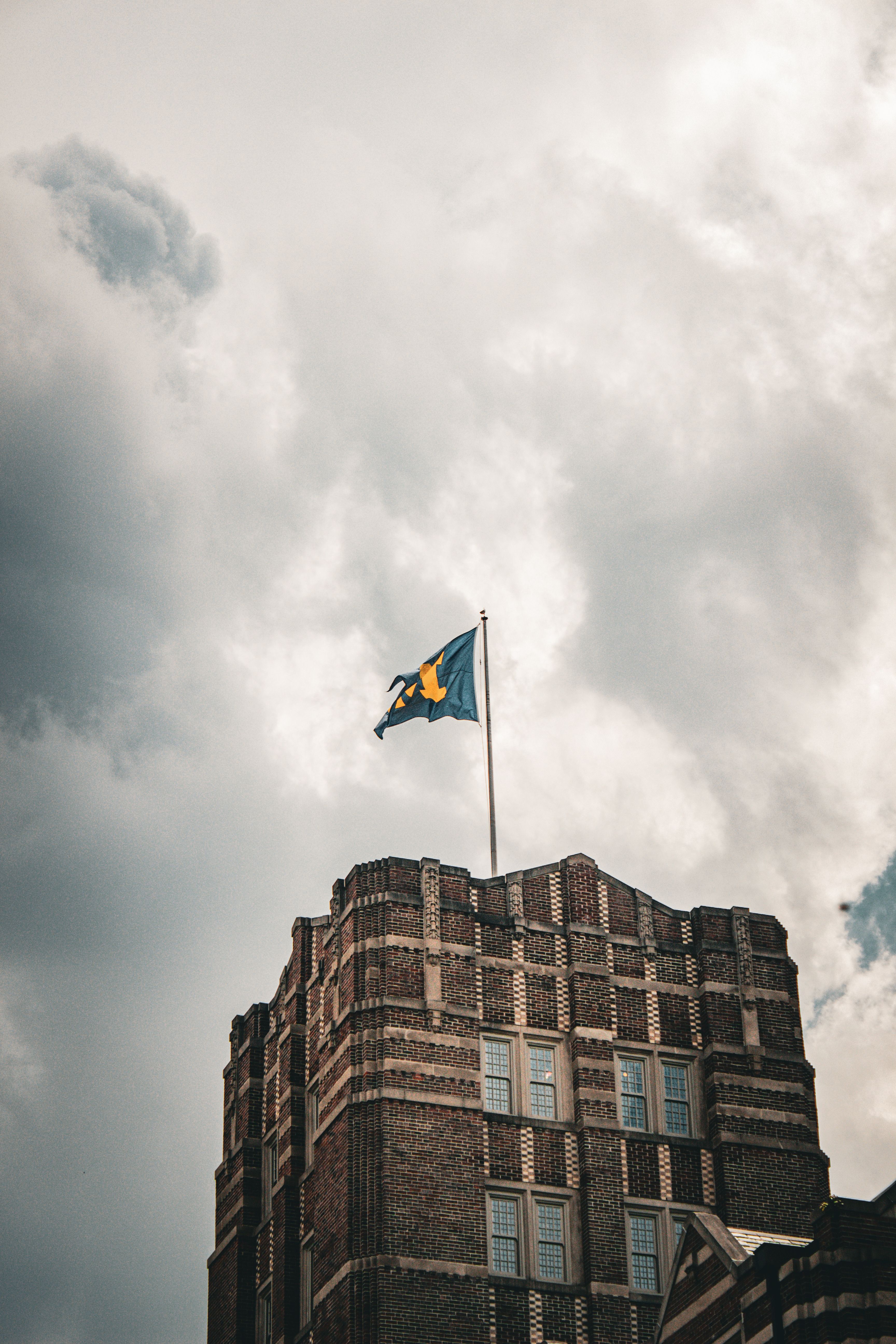 Building Facade of the University of Michigan with a Flag on Top · Free ...