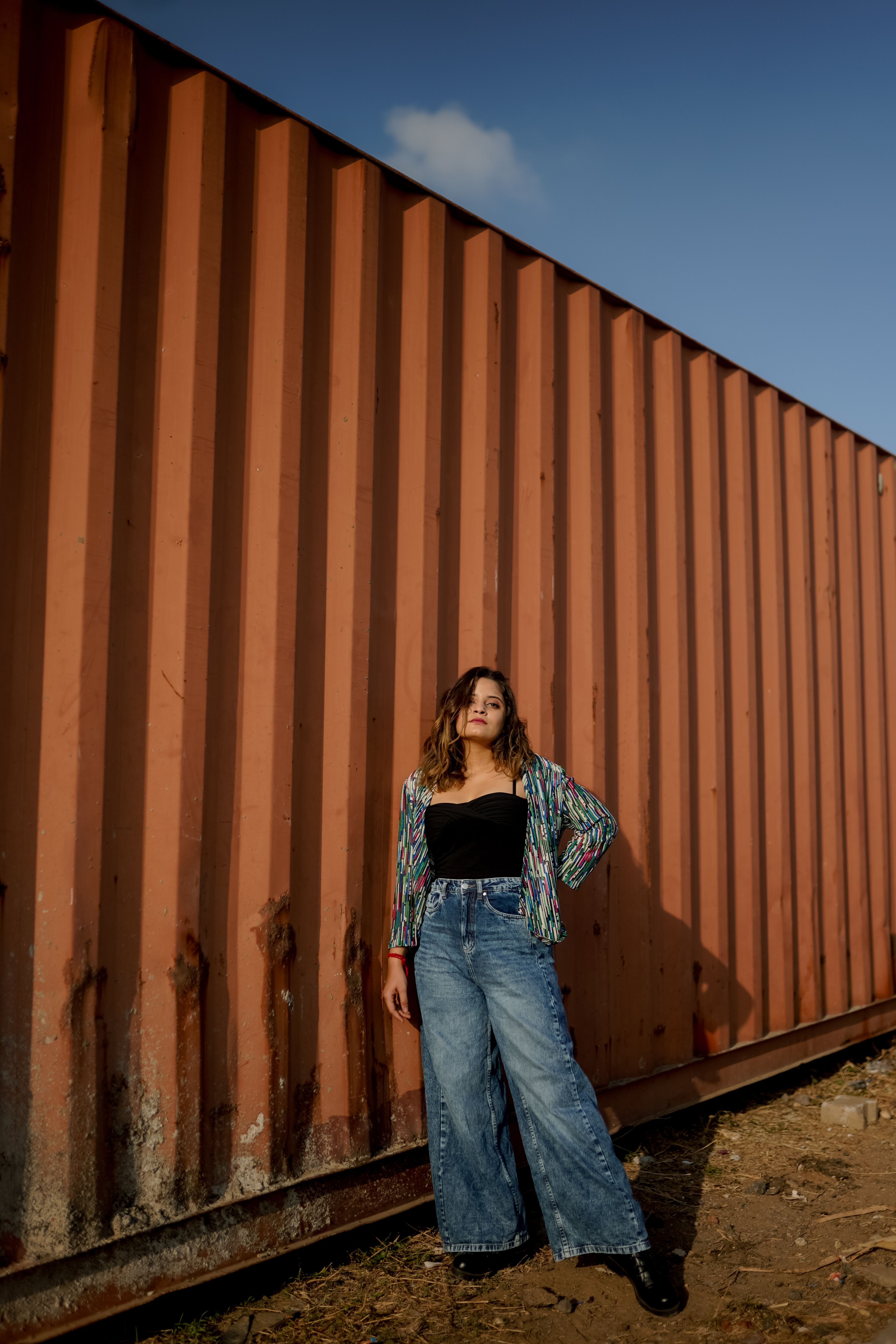 Portrait of a Woman Posing by a Shipping Container · Free Stock Photo
