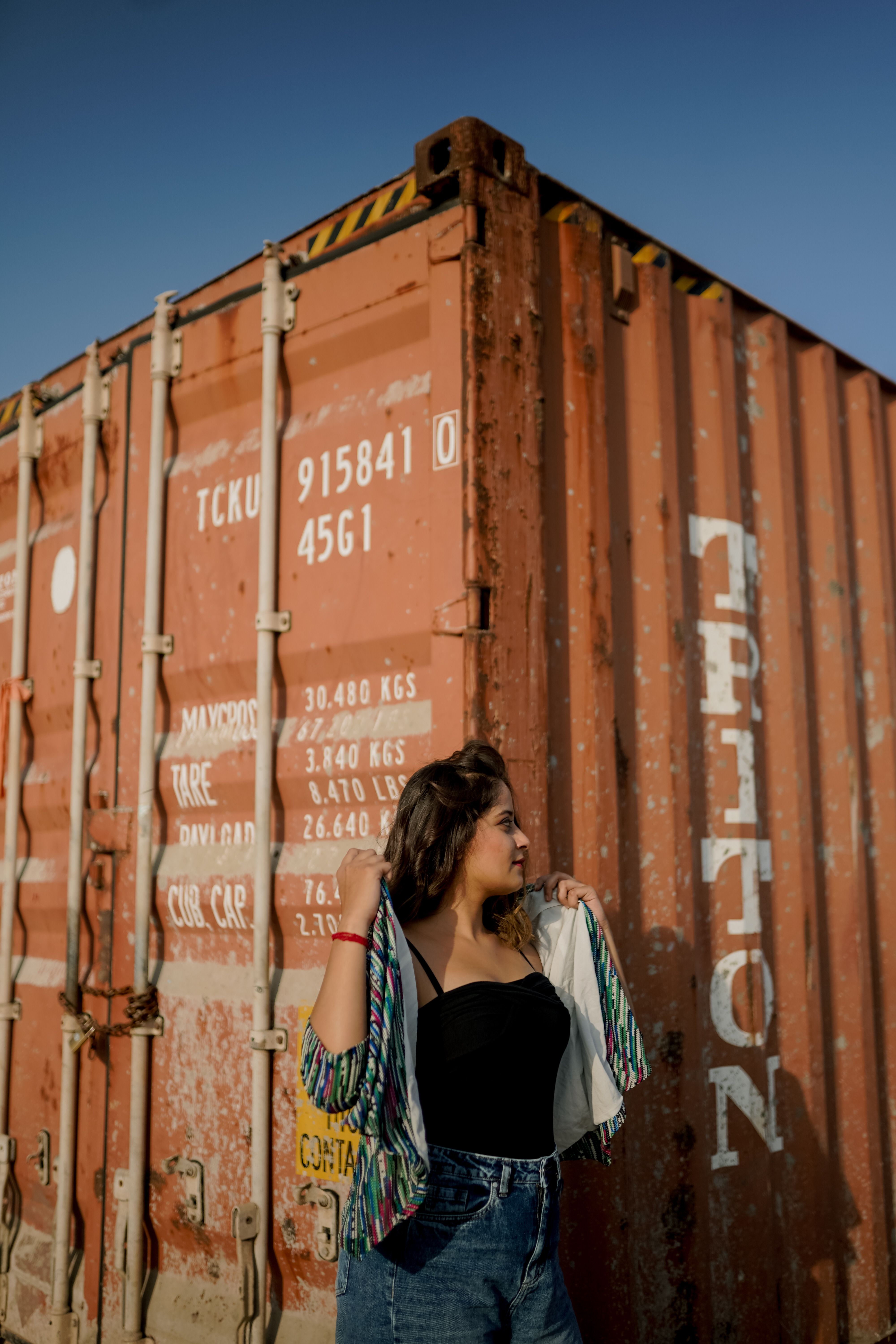 Woman Posing against a Cargo Container · Free Stock Photo