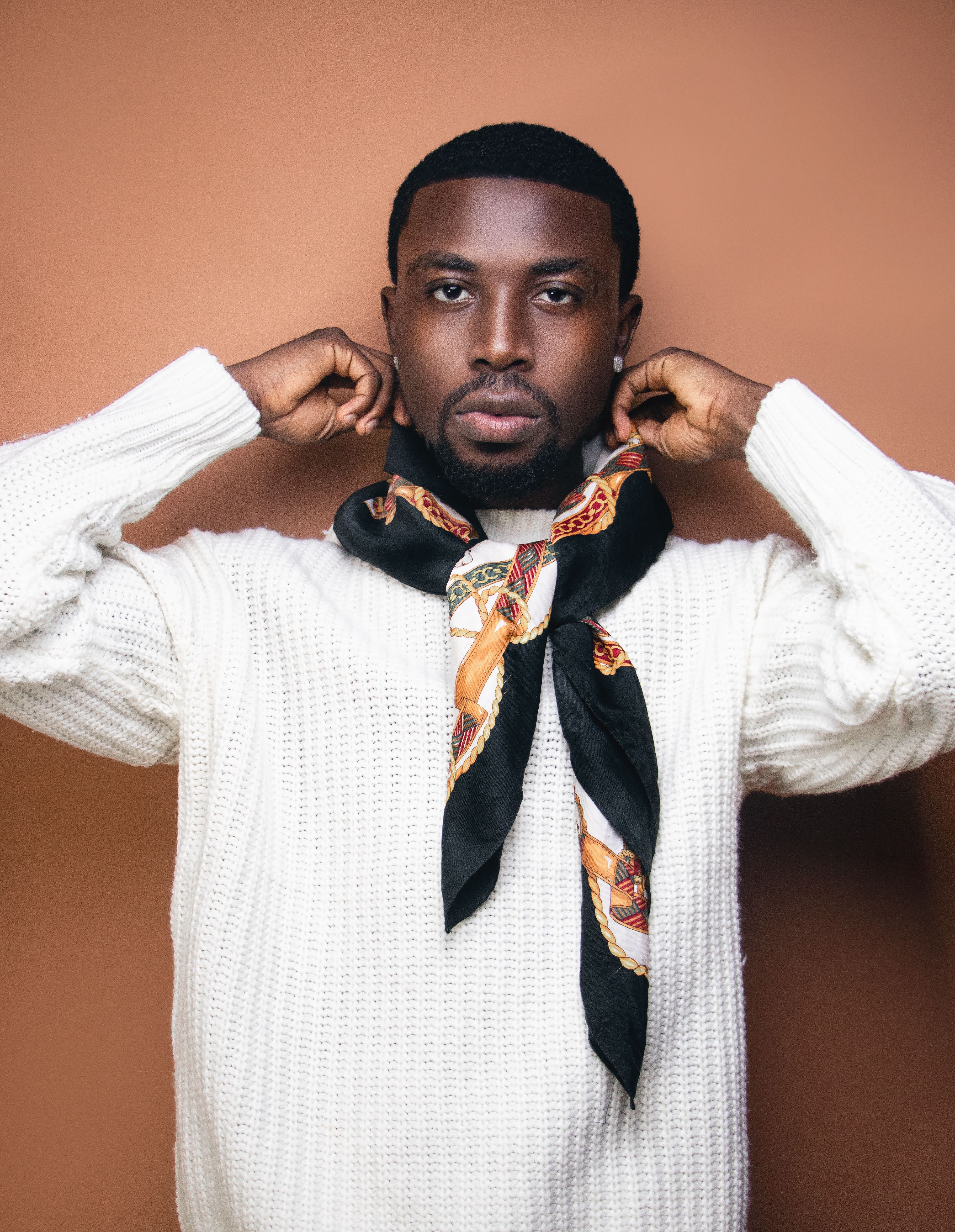 Studio Portrait of a Male Model Wearing a White Sweater and a Black ...