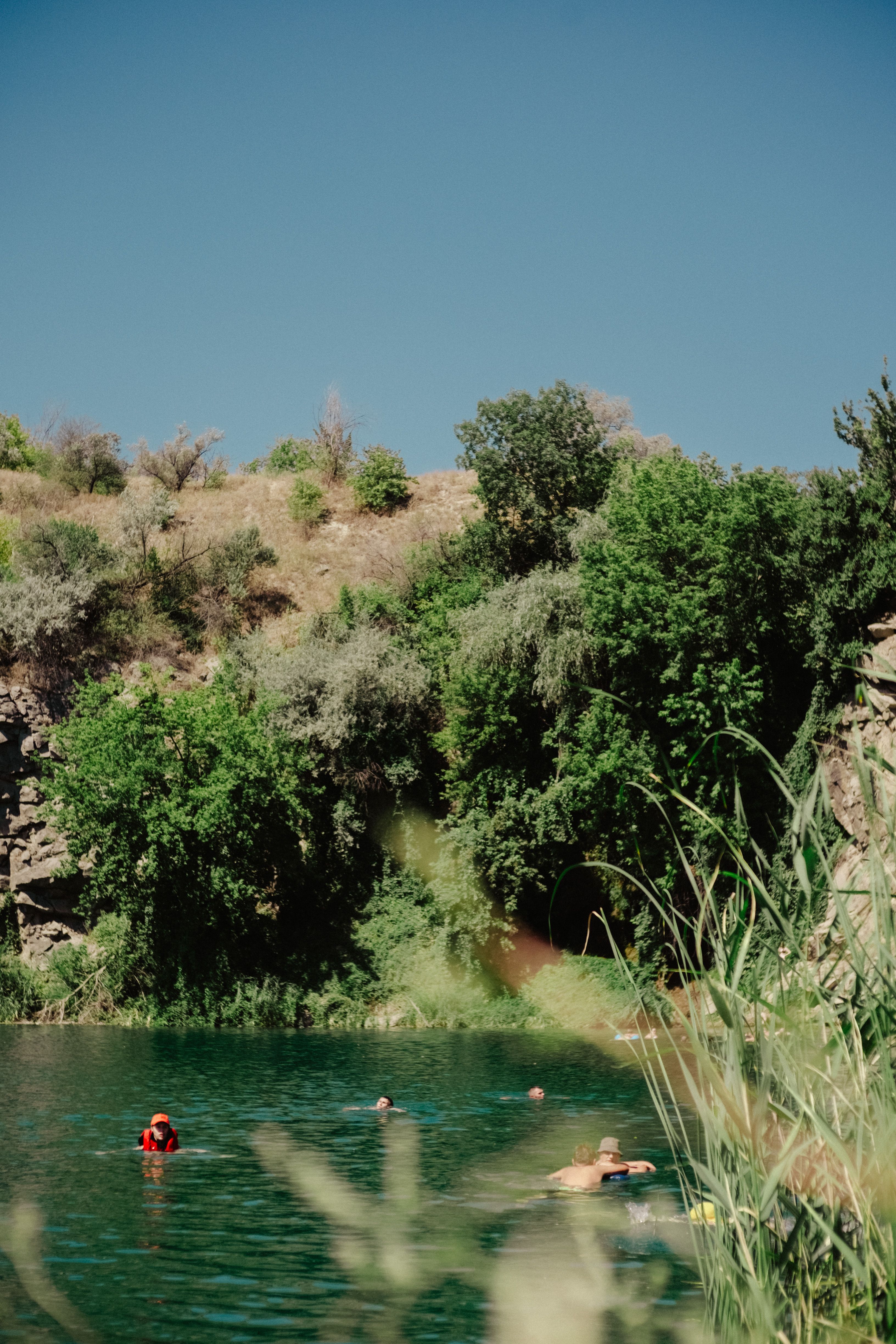 A group of people swimming in a lake · Free Stock Photo