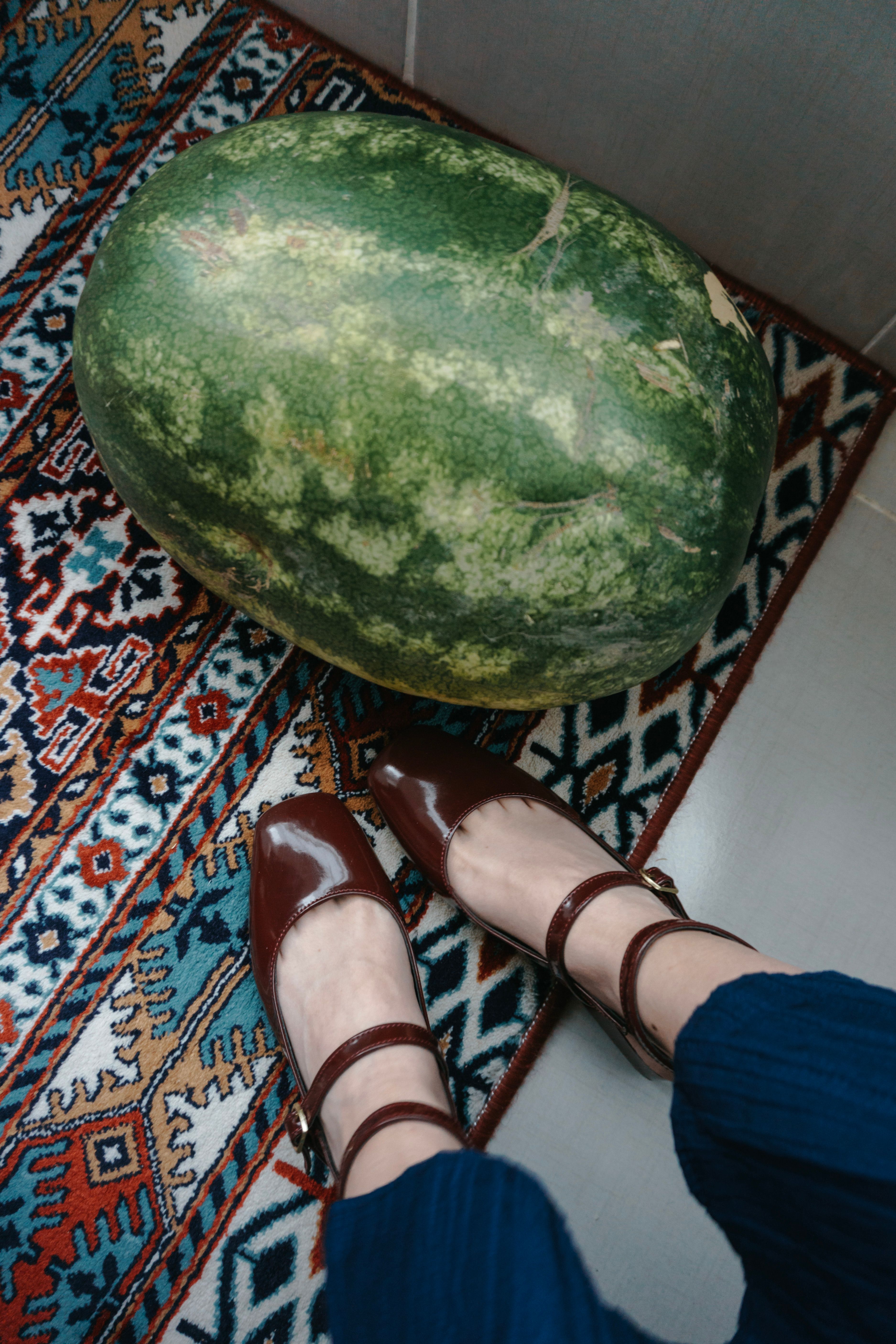 Watermelon and Woman Legs on Traditional Carpet · Free Stock Photo