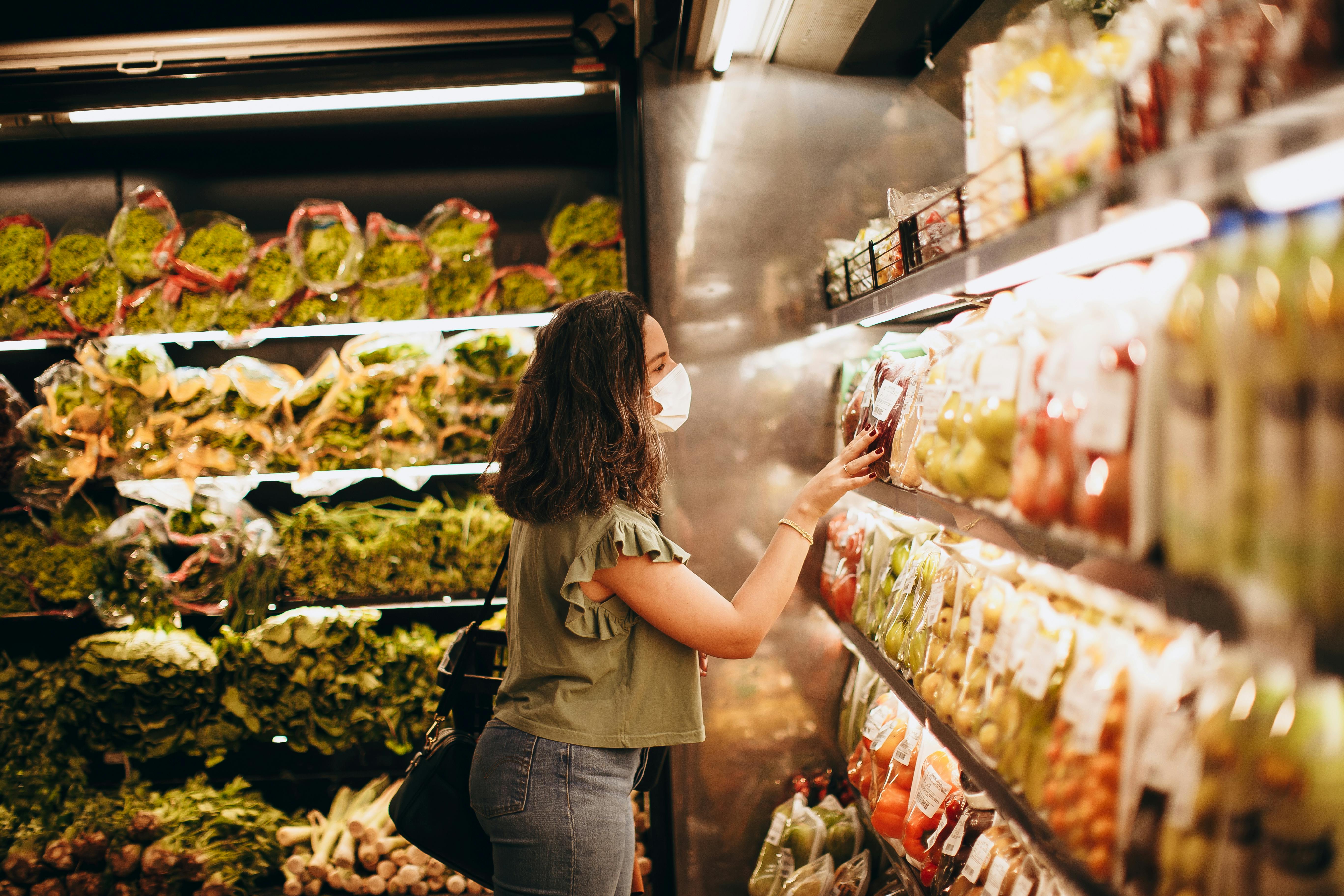 Woman Browsing through Groceries on a Shelf in a Supermarket · Free ...