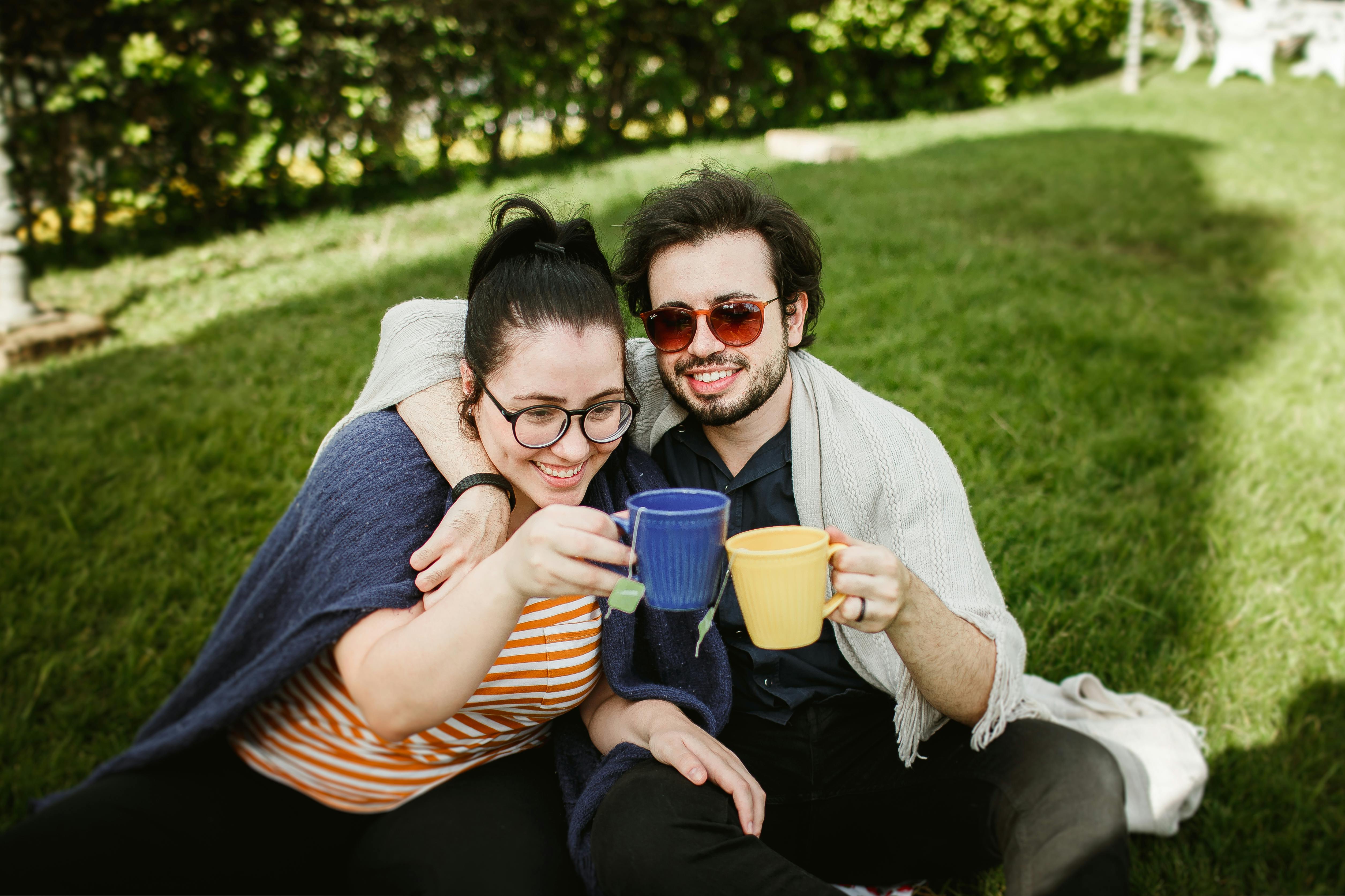 Portrait of Hugging Couple in Sunglasses and Hugging with Cups · Free ...