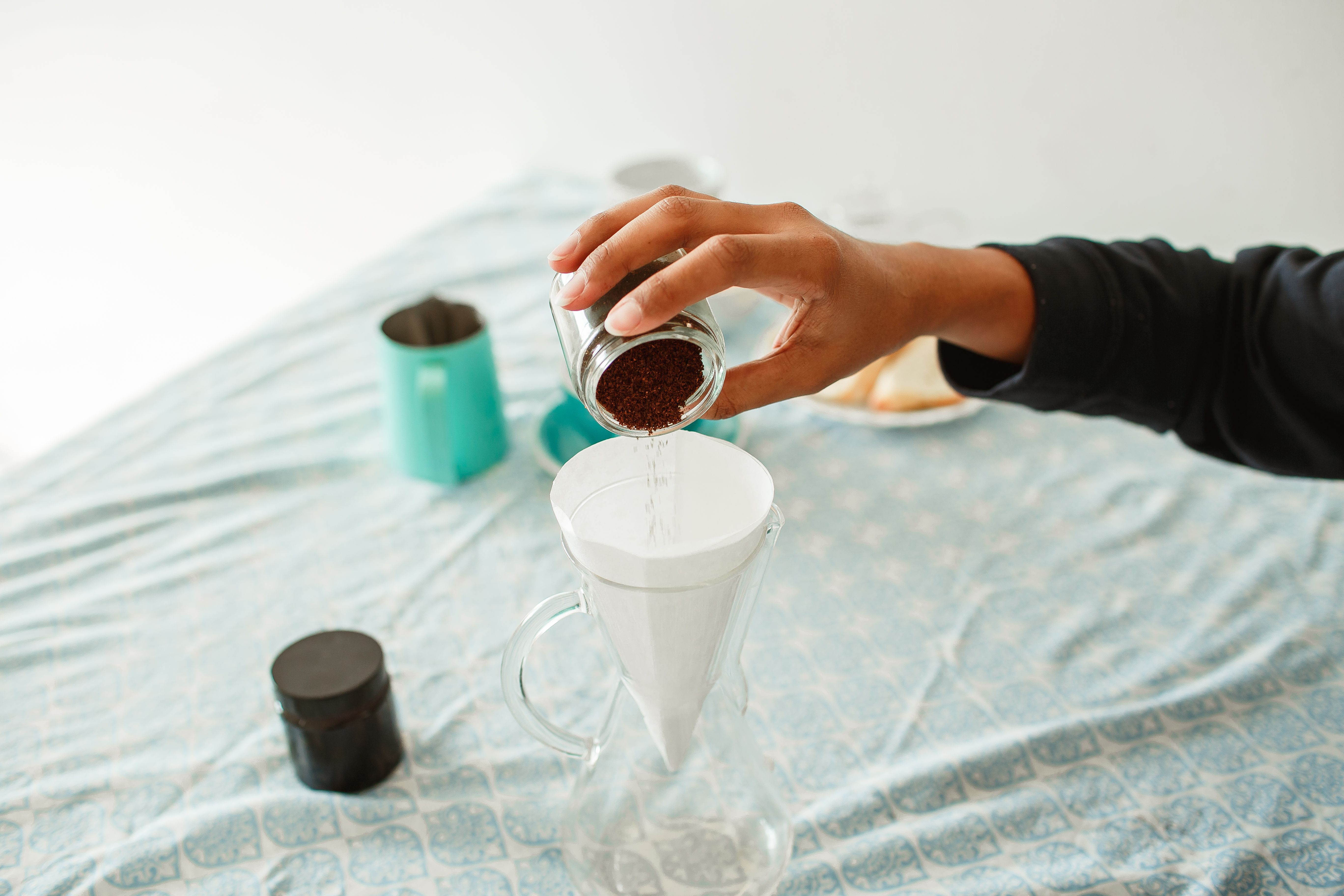 Hand Pouring Coffee Grains into Filter · Free Stock Photo