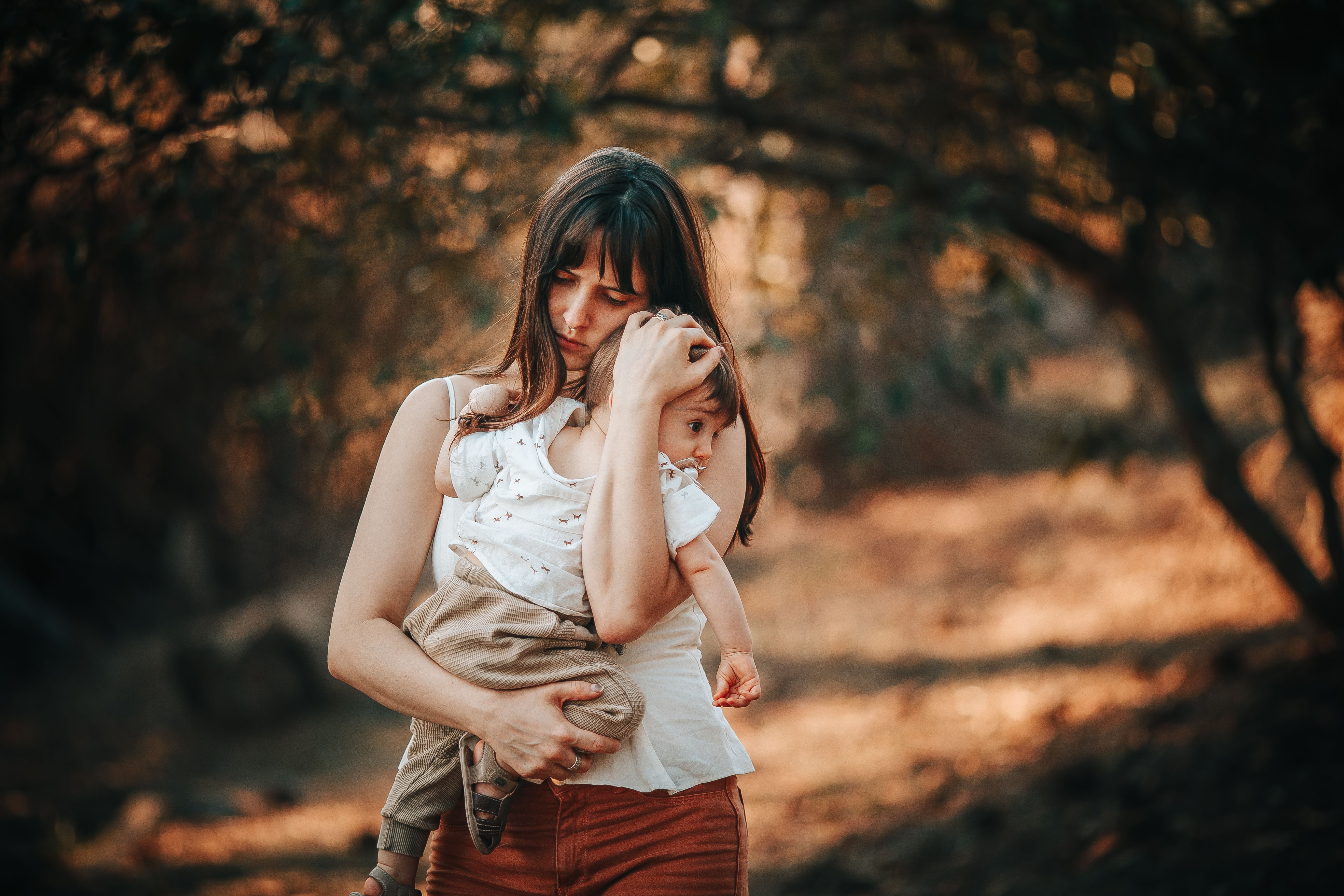 Brunette Woman Embracing Child in Hands · Free Stock Photo