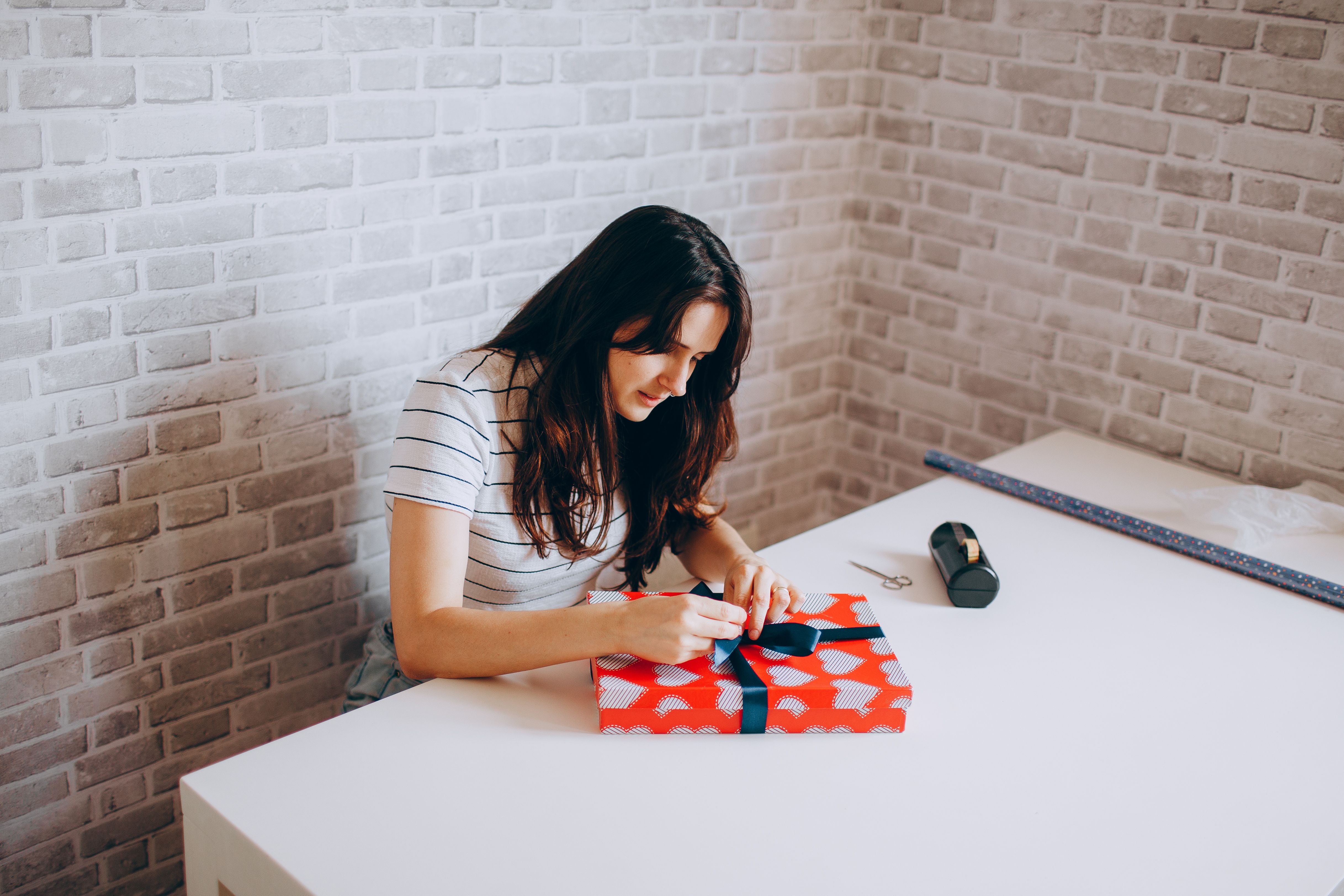 Woman Packing Present in Box · Free Stock Photo