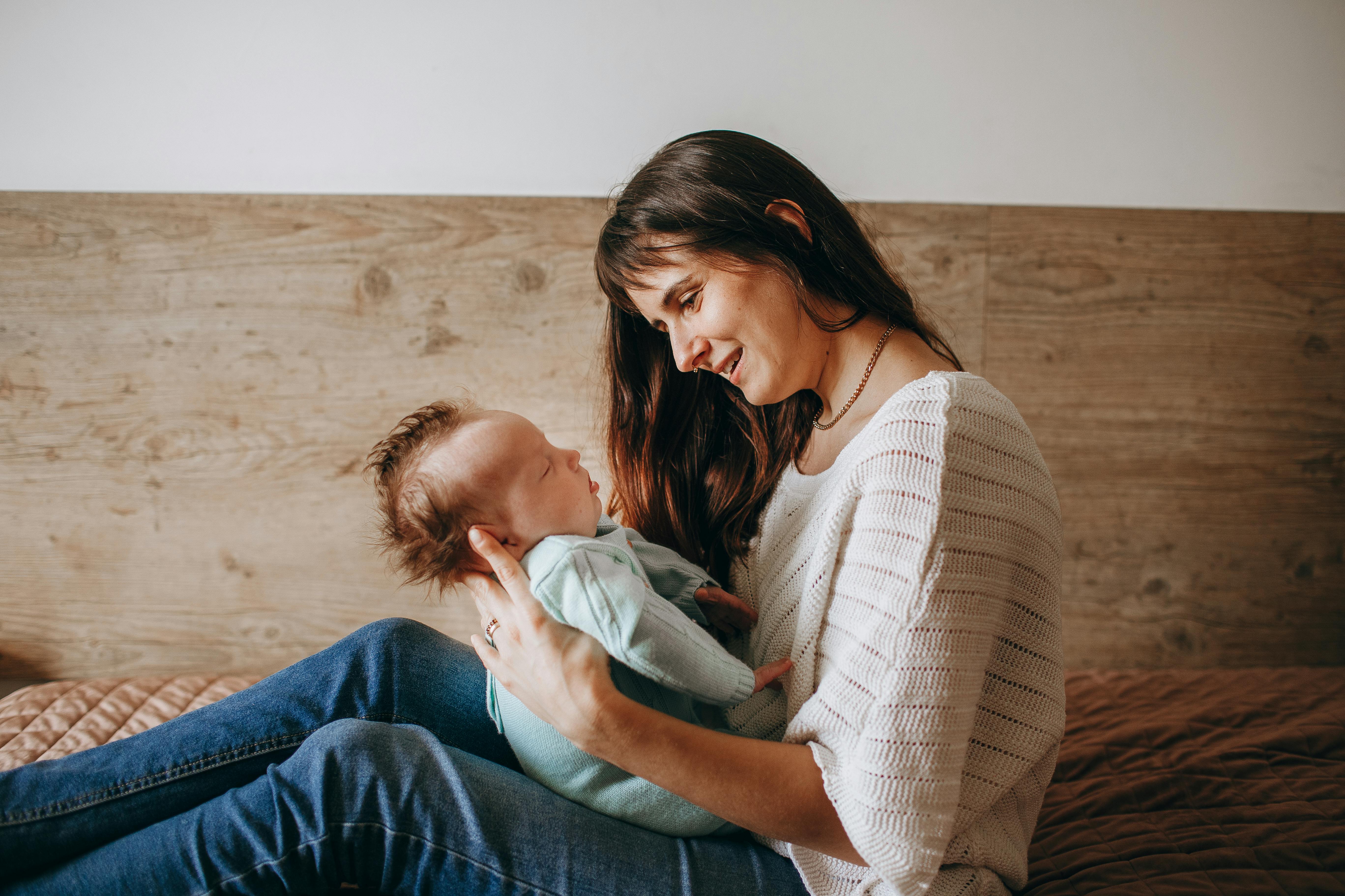 Woman Carrying Baby · Free Stock Photo