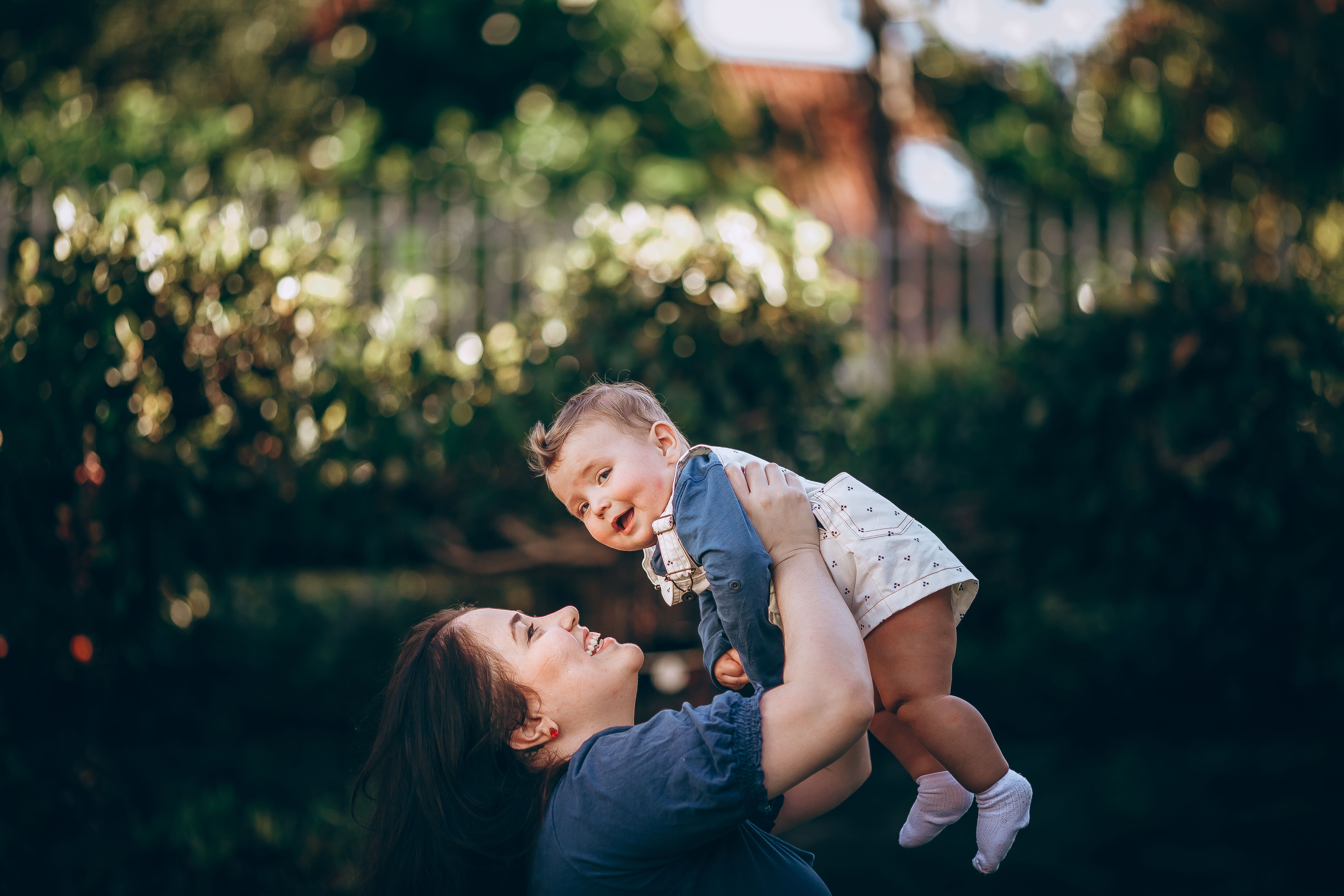 Smiling Man Carrying Baby on His Neck · Free Stock Photo