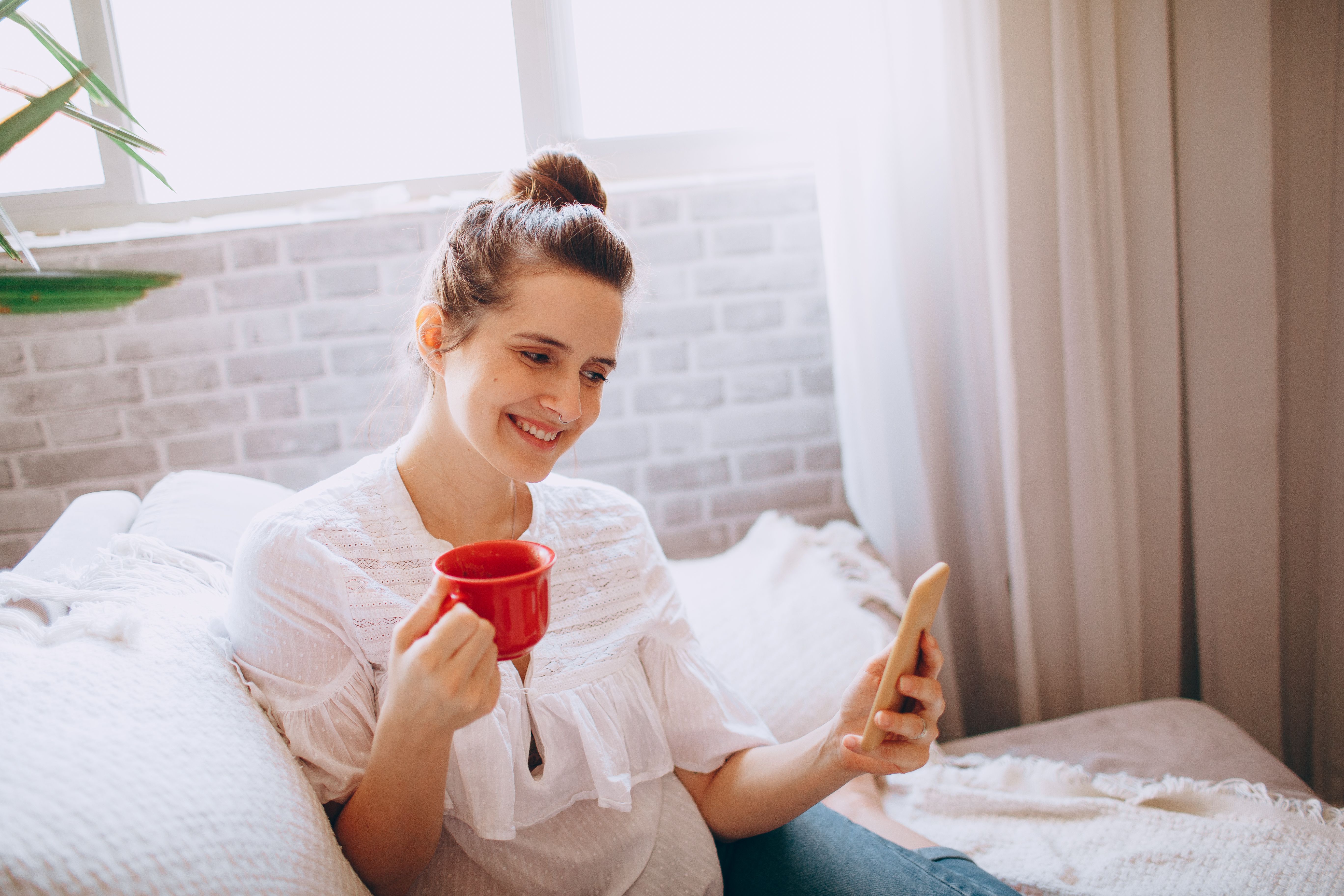 Woman with Red Cup Talking by Phone · Free Stock Photo