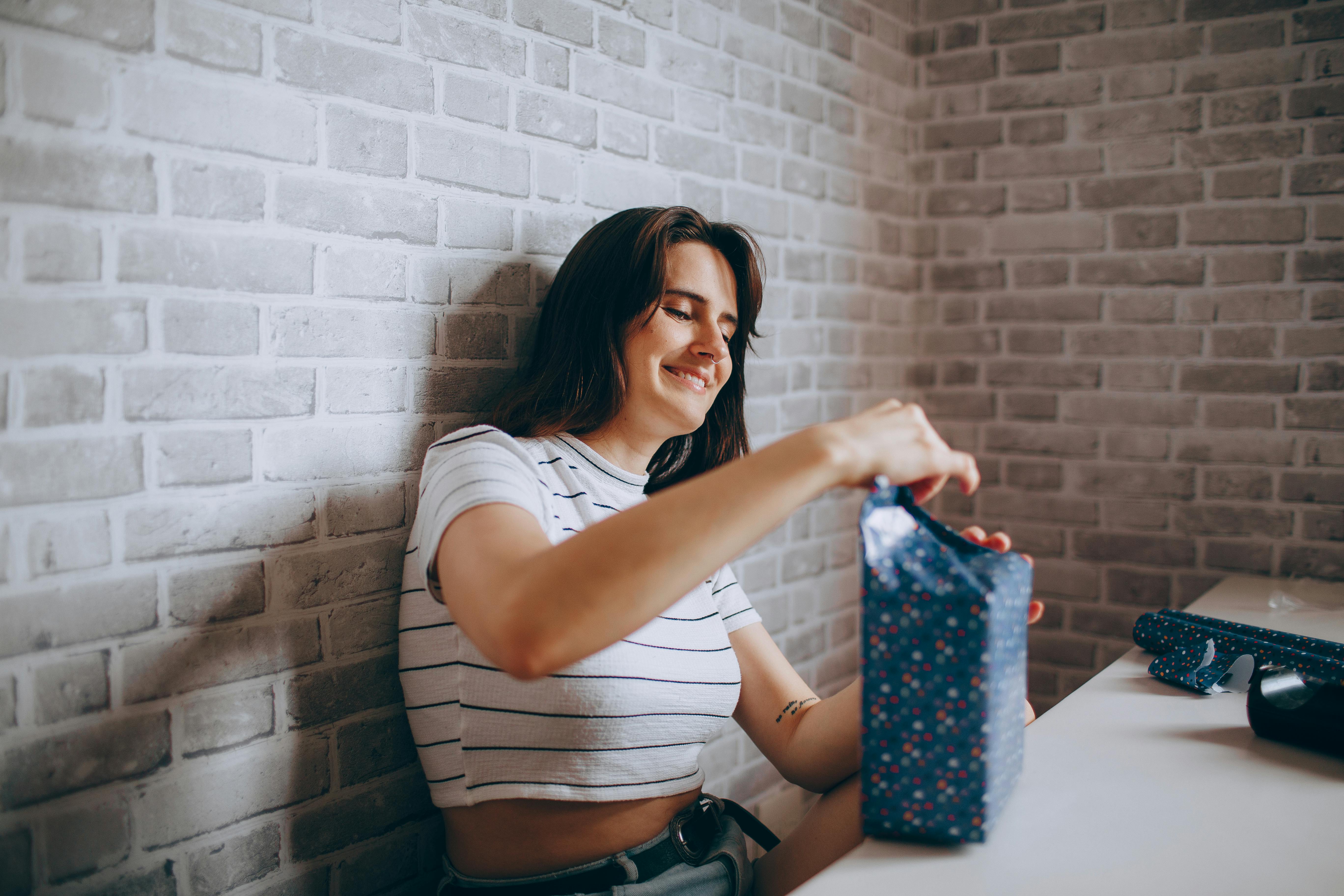 Woman Unpacking a Gift · Free Stock Photo