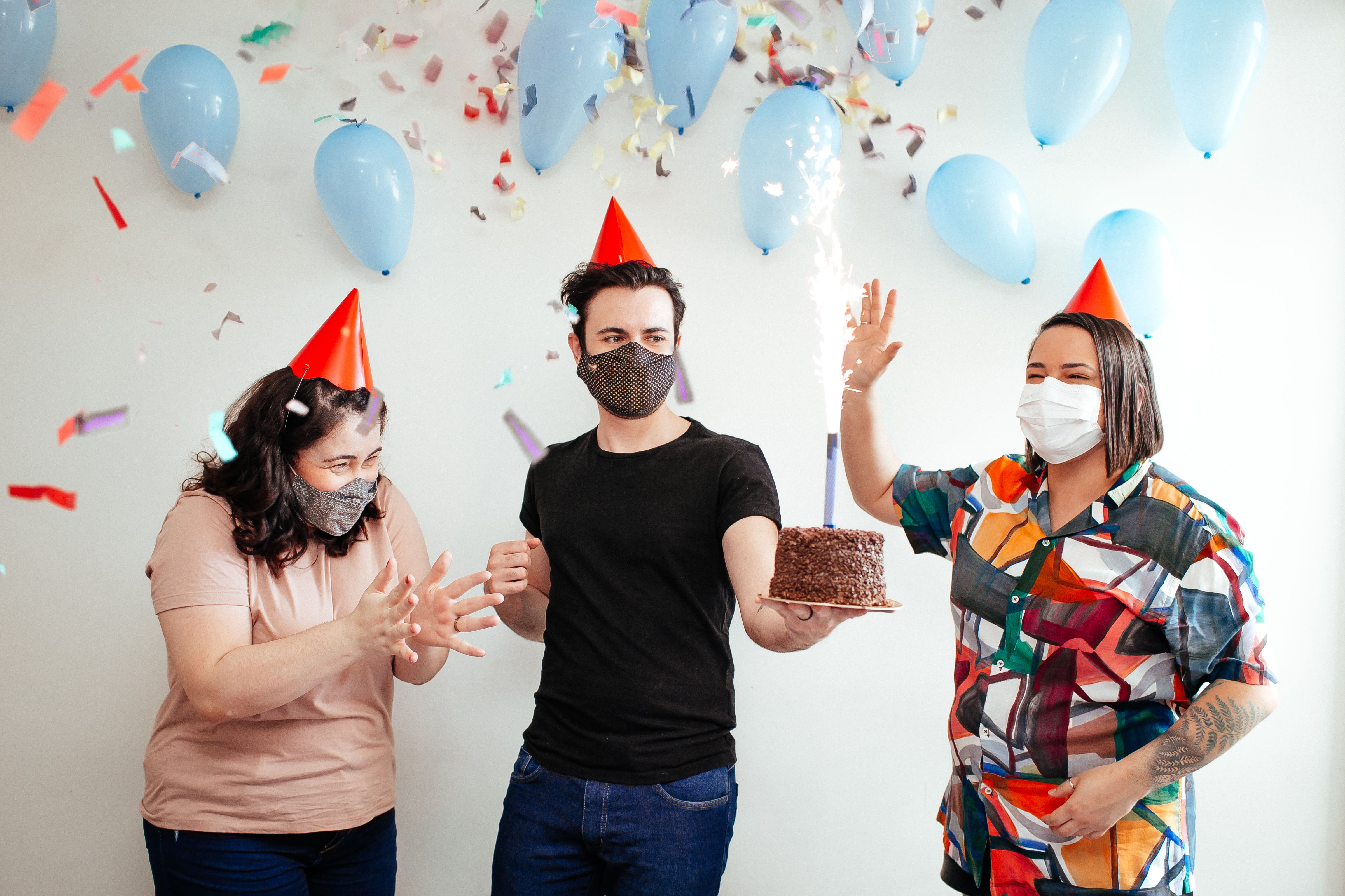 Man Standing with Women and Holding Birthday Cake · Free Stock Photo