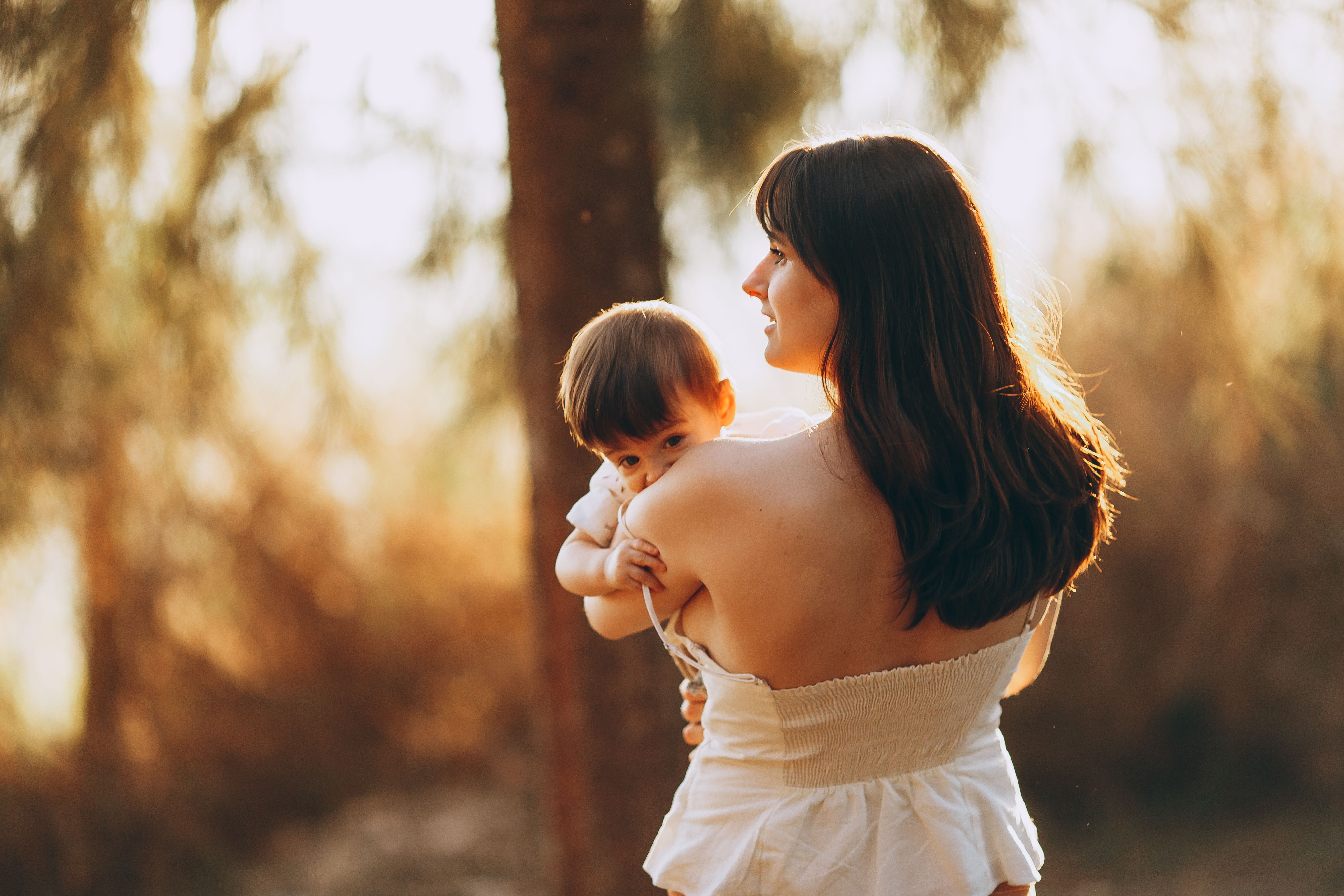 Woman Standing with Child in Forest · Free Stock Photo