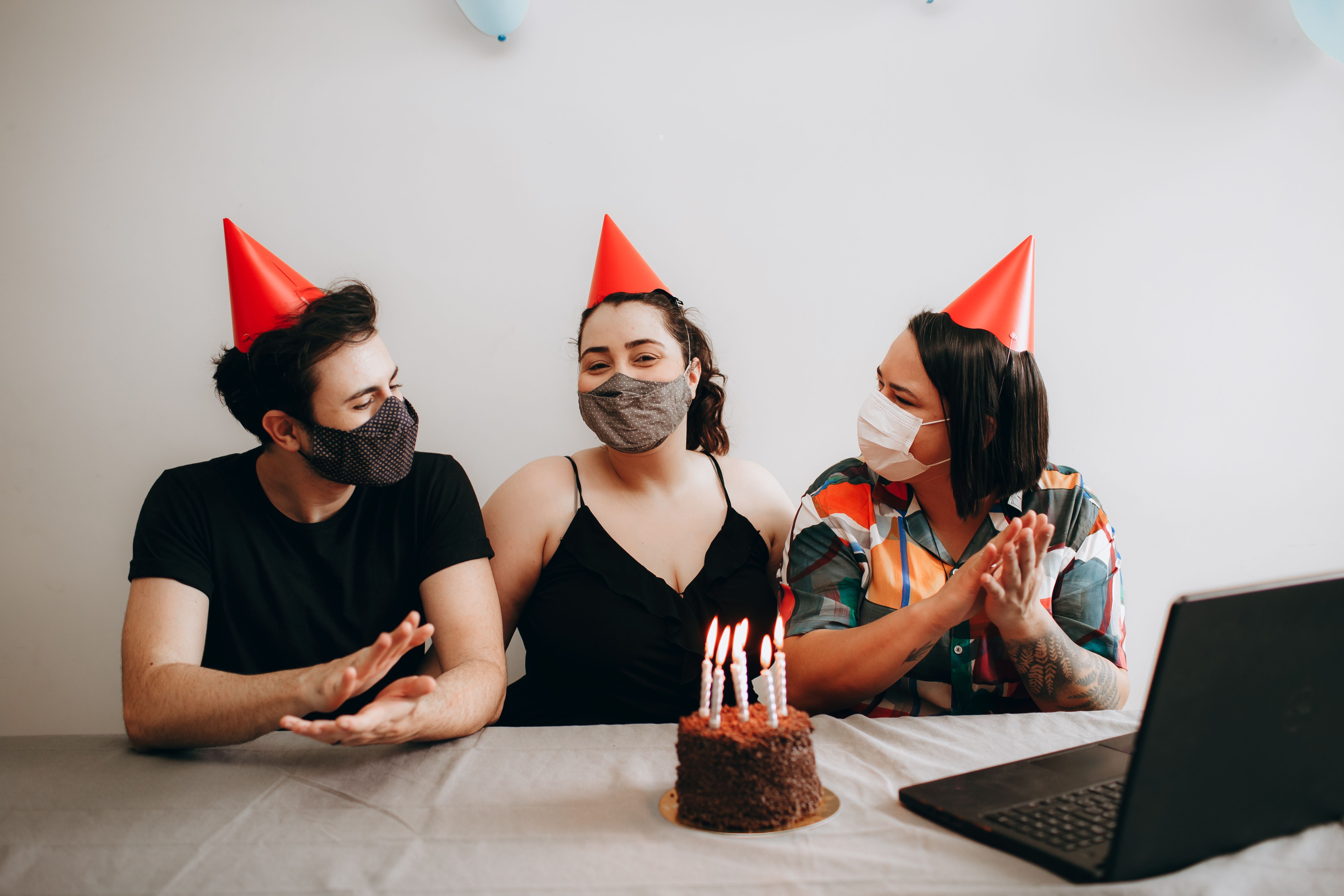 Man and Women in Face Masks Celebrating Birthday · Free Stock Photo
