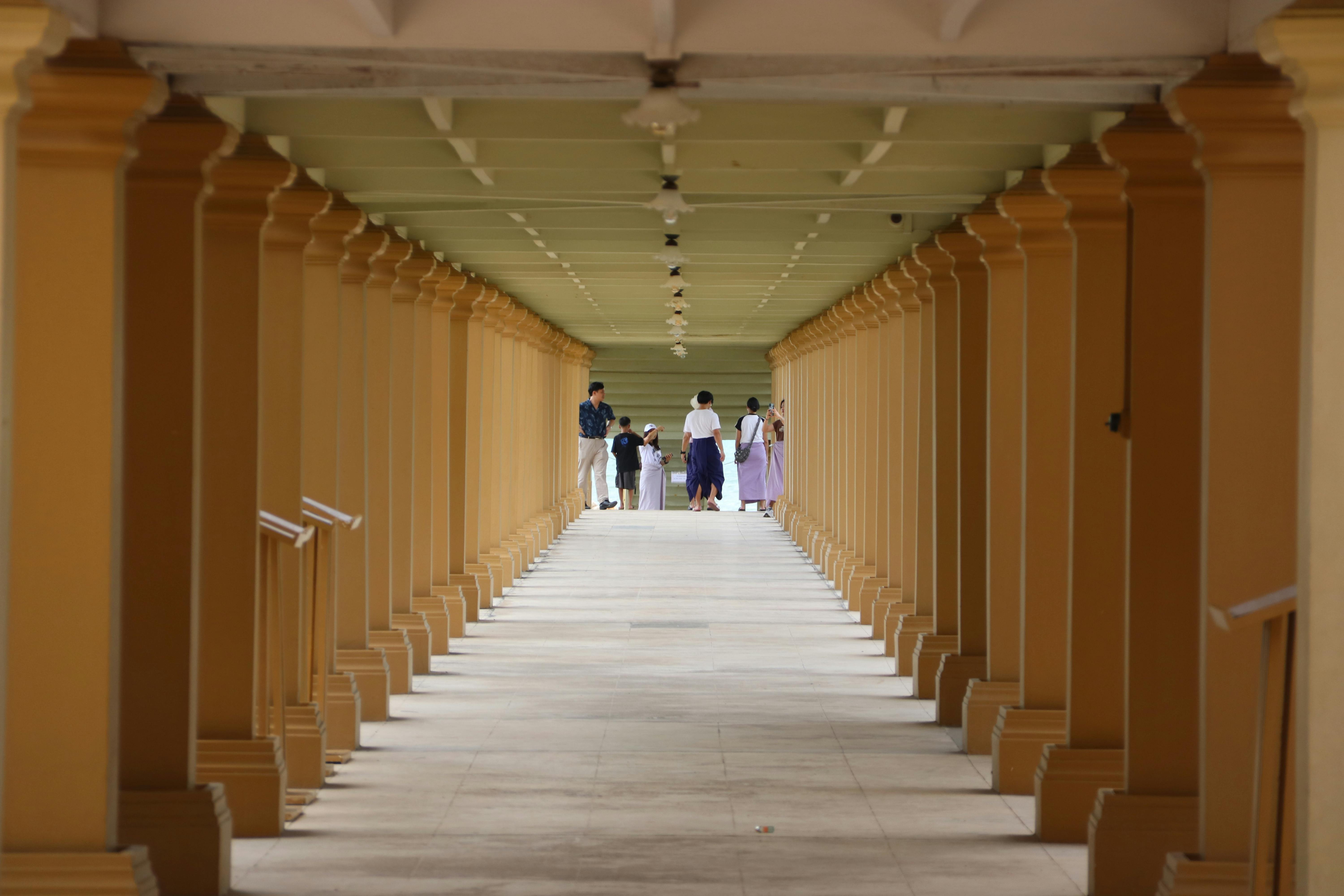 People in Corridor with Columns · Free Stock Photo