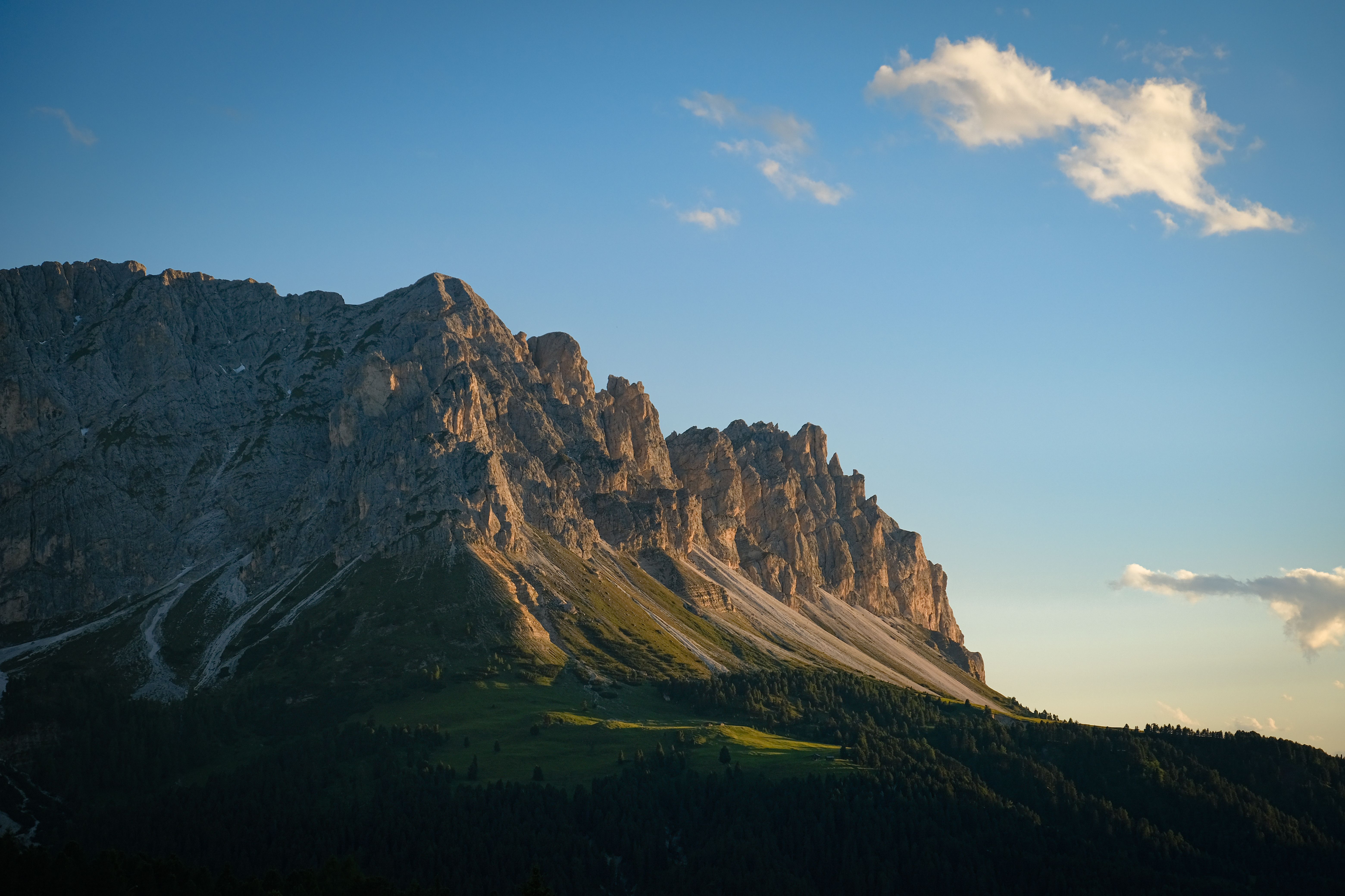 A mountain with a large rock formation in the background · Free Stock Photo