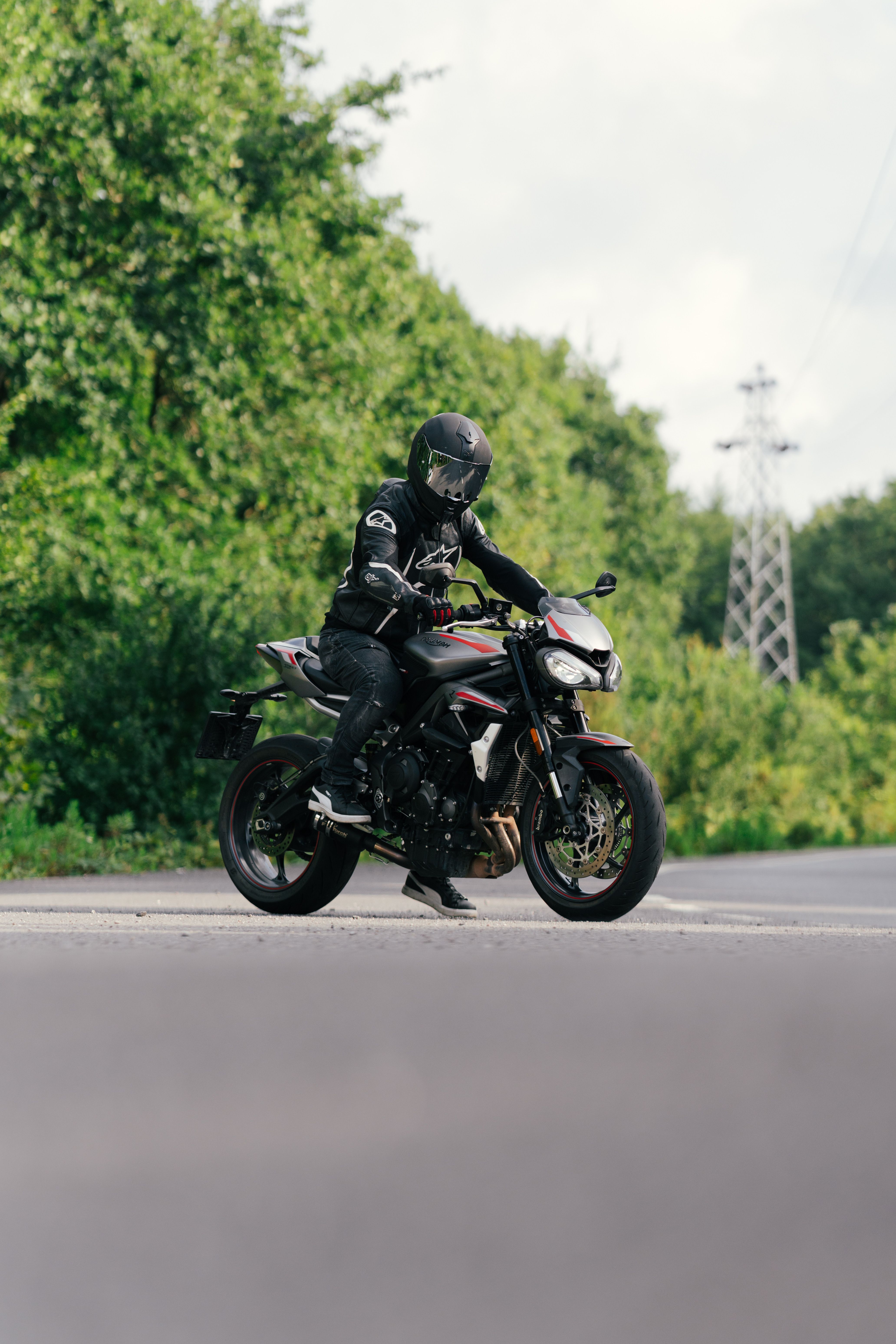 Photo of a Motorcyclist Riding a Motorcycle on a Street · Free Stock Photo