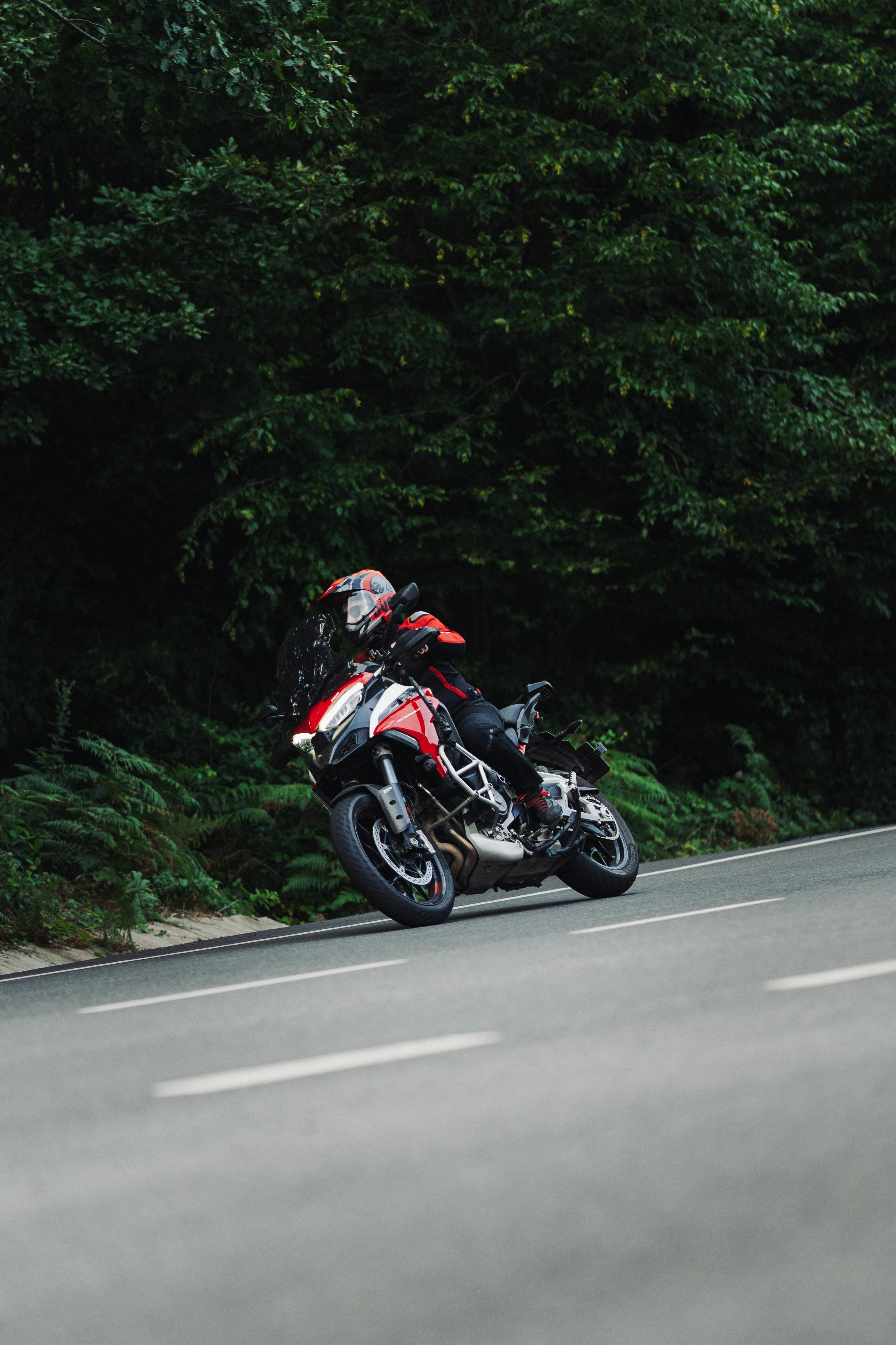 Man Riding Motorcycle in Forest · Free Stock Photo