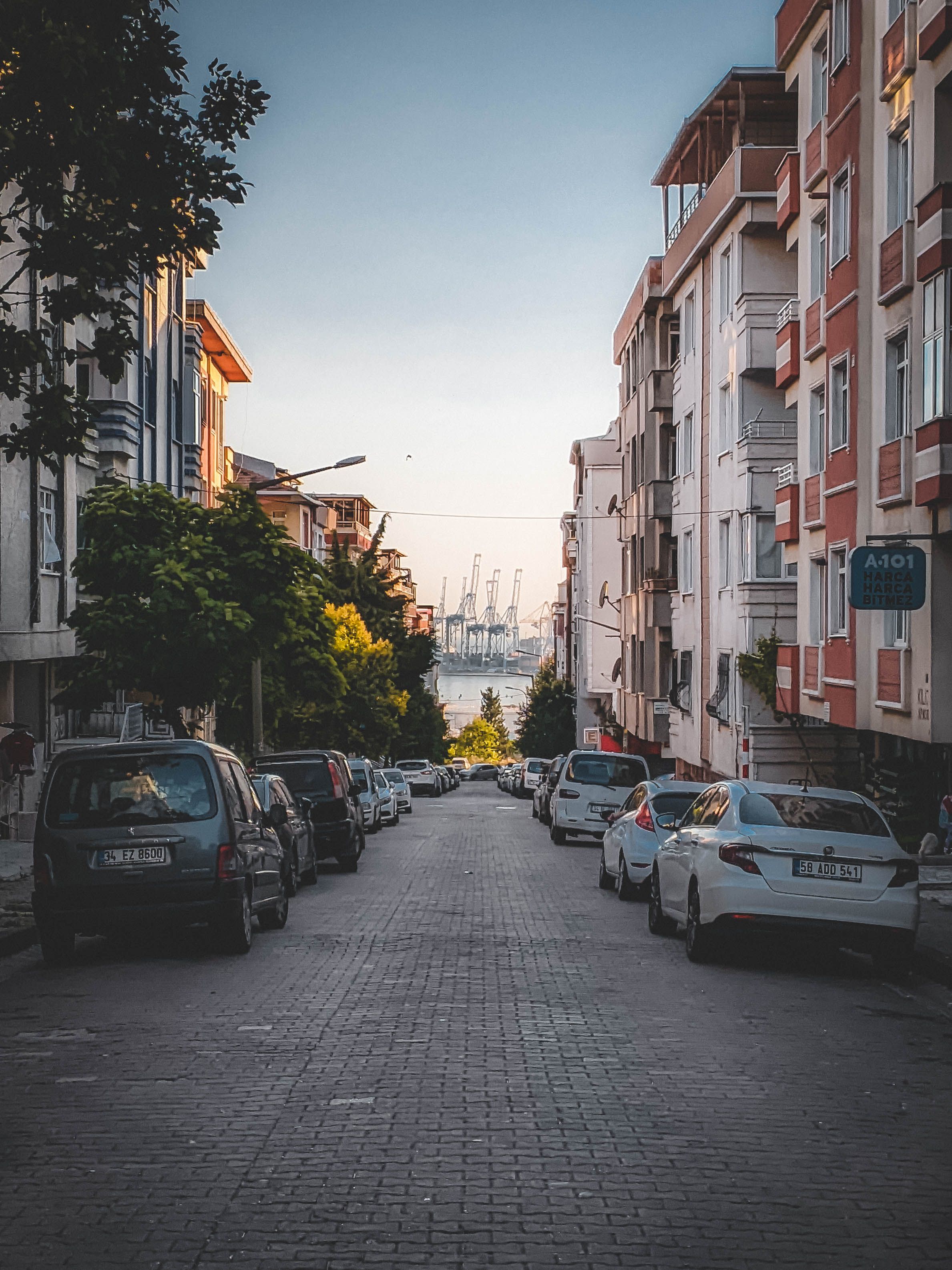 A Street with Parked Cars between the Apartment Buildings in a City ...