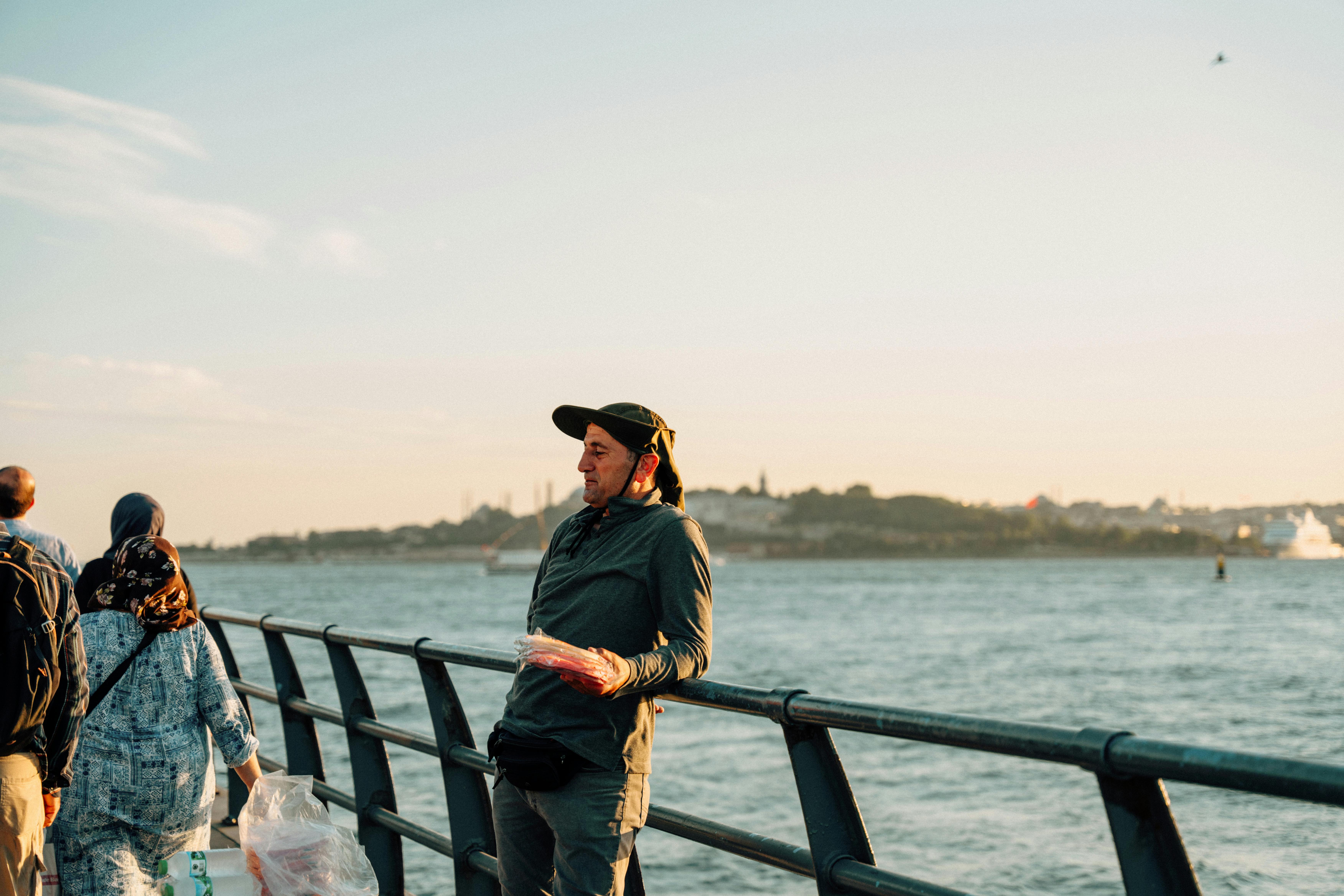 A Man Standing on a Bridge and Leaning against the Railing · Free Stock ...