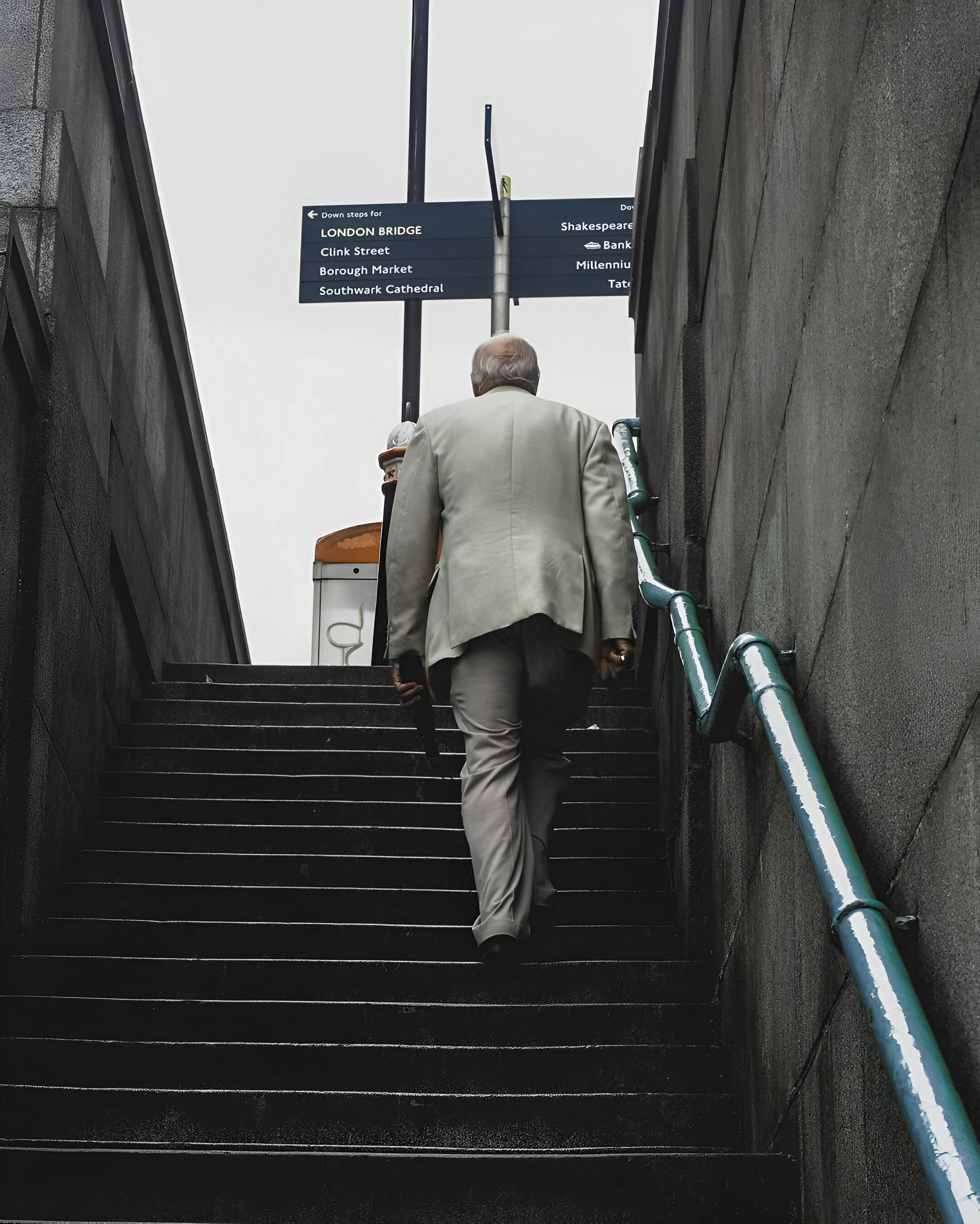 Back View of an Elderly Man Walking Up the Stairs · Free Stock Photo