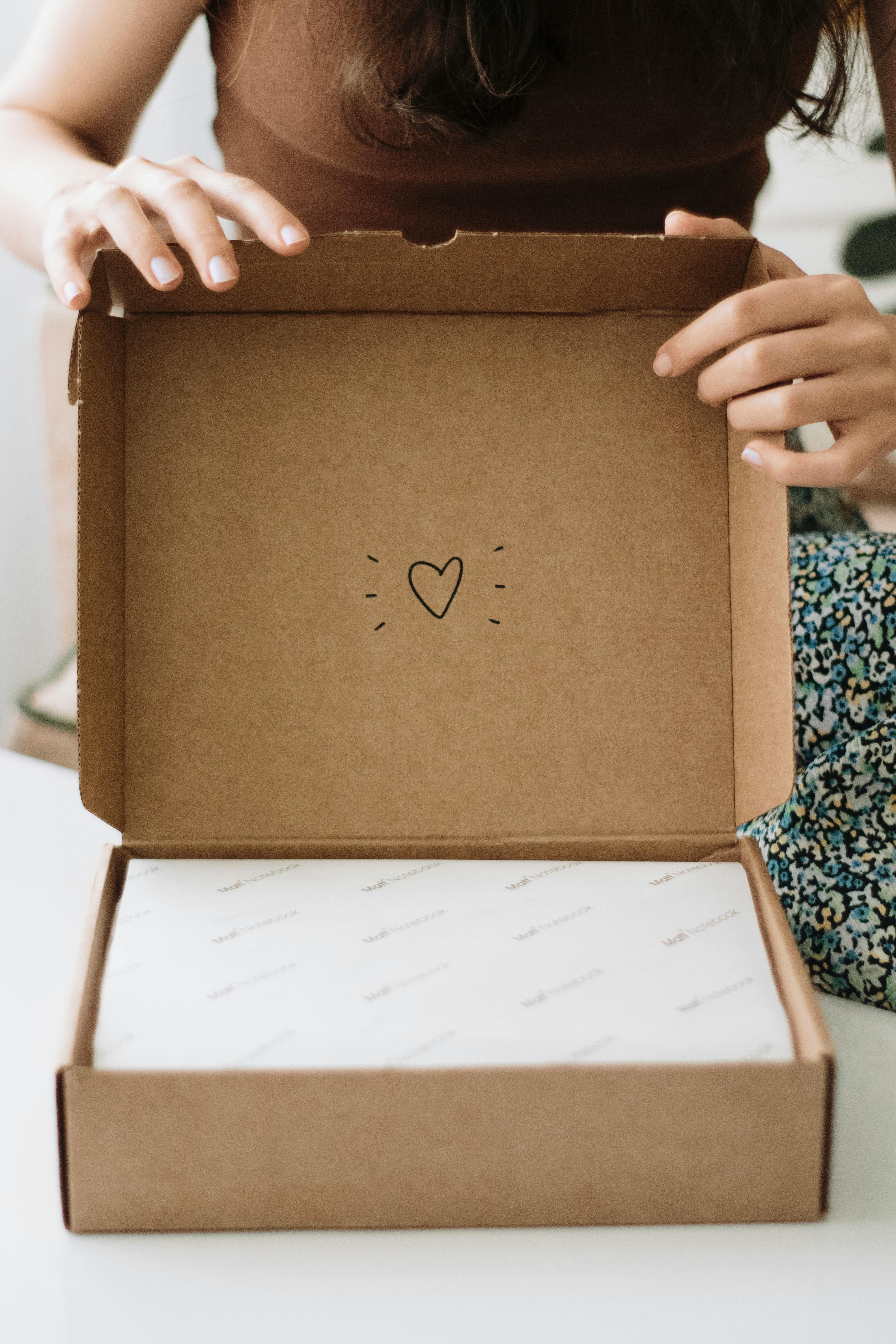 A Woman Opening a Box · Free Stock Photo