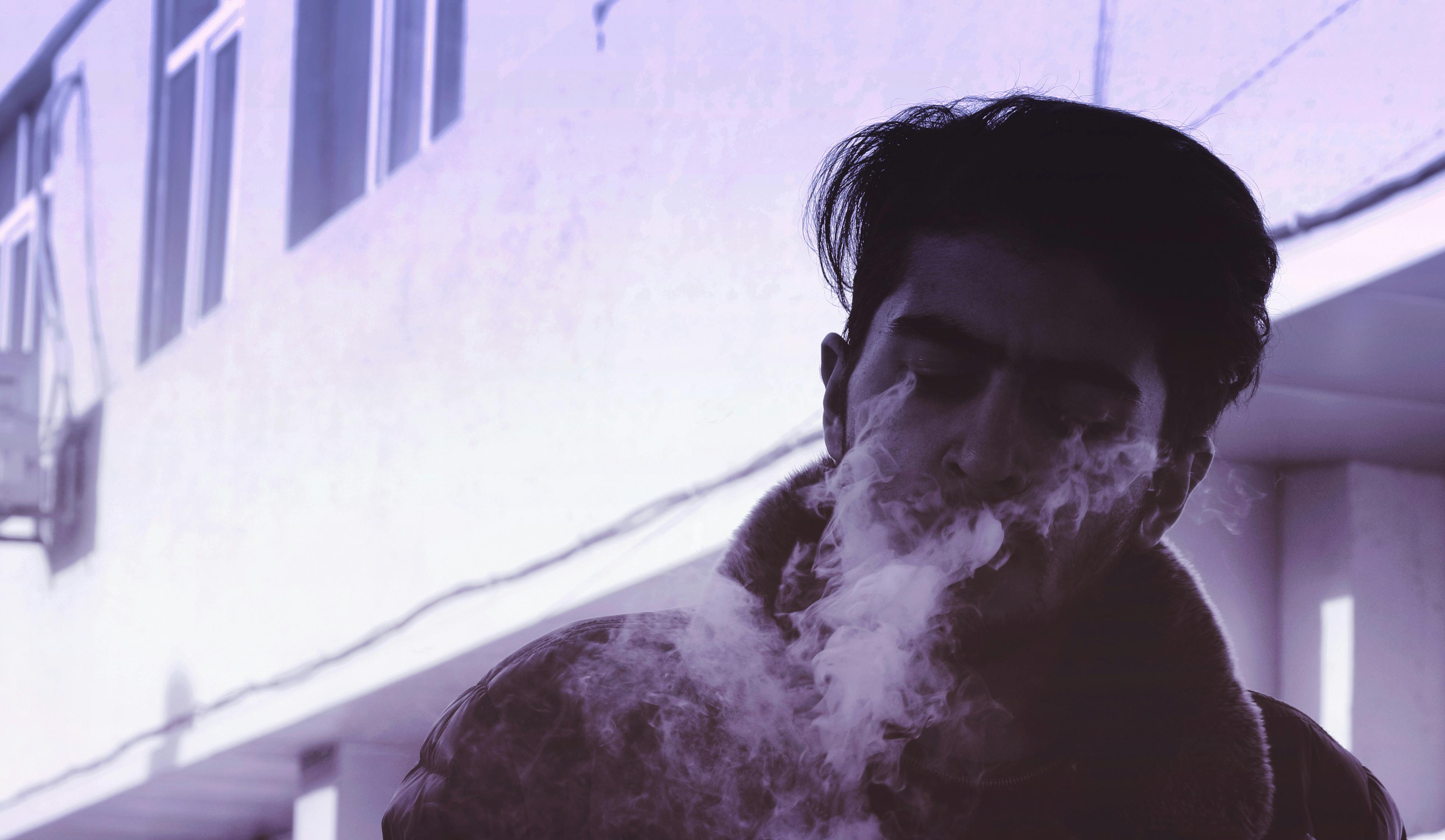 Man in Black Puffer Jacket and Distress Jeans Sitting in Couch · Free ...