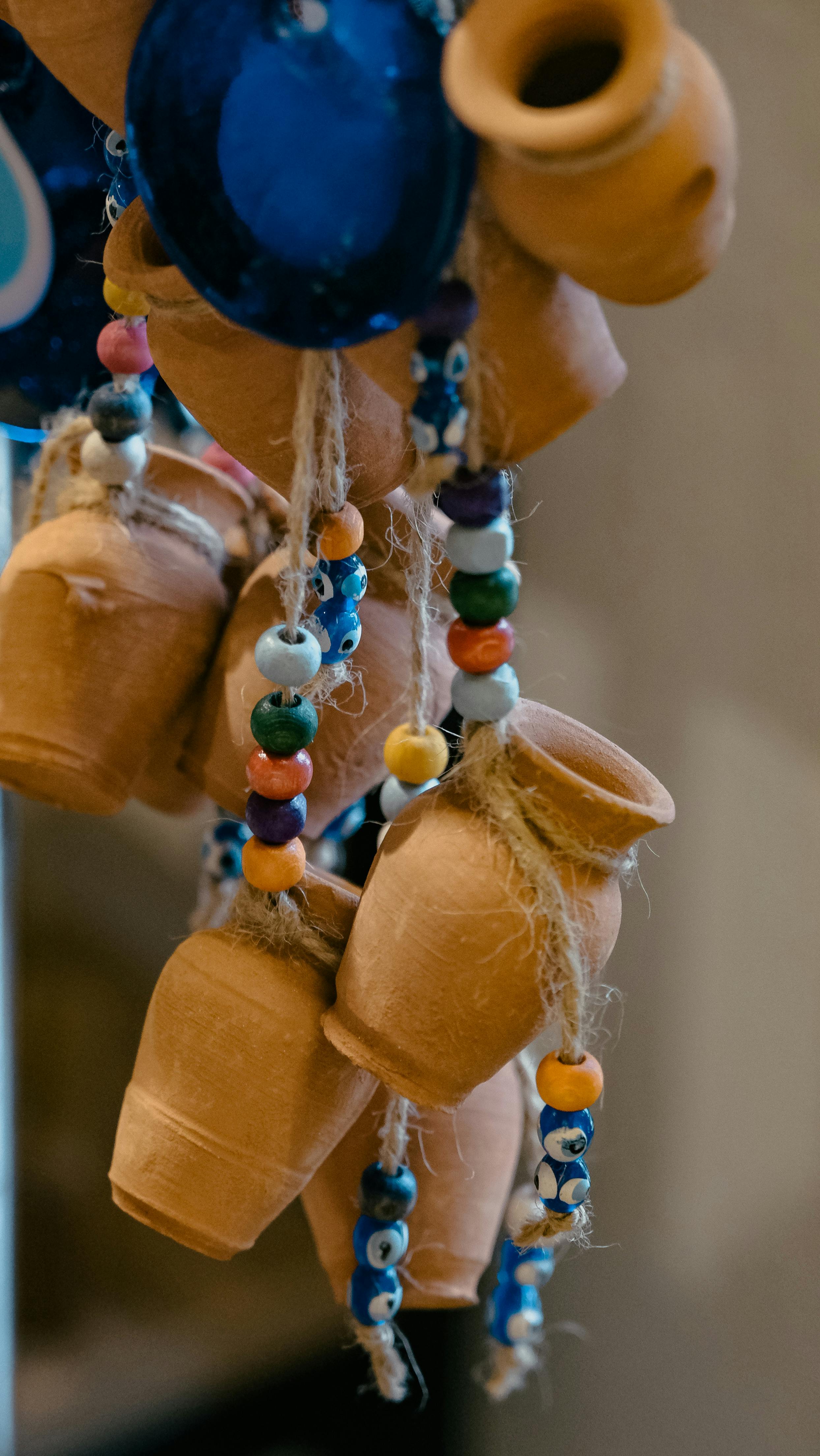 A close up of a wooden bird chime with beads · Free Stock Photo