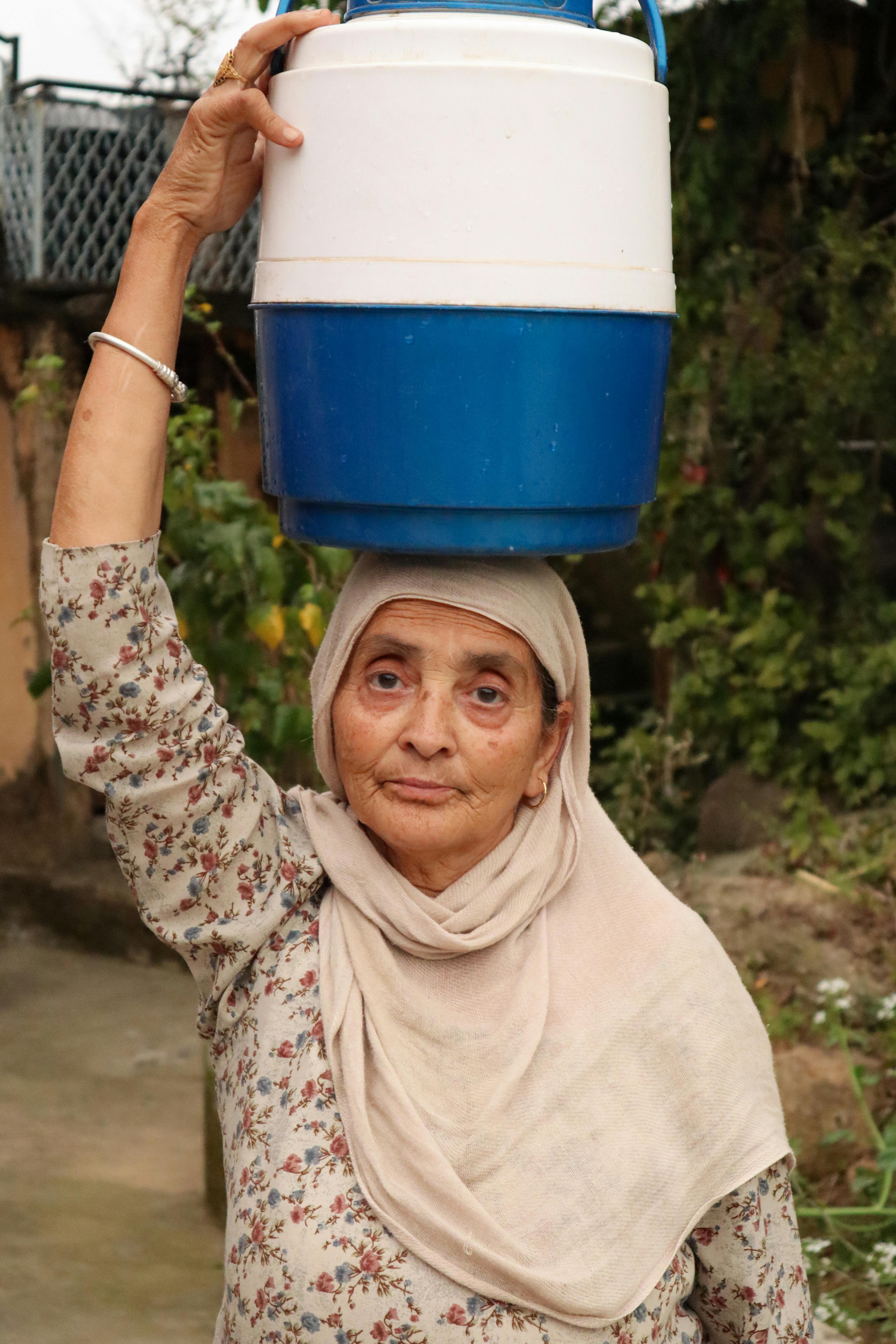 Woman Carrying Keg on Head · Free Stock Photo