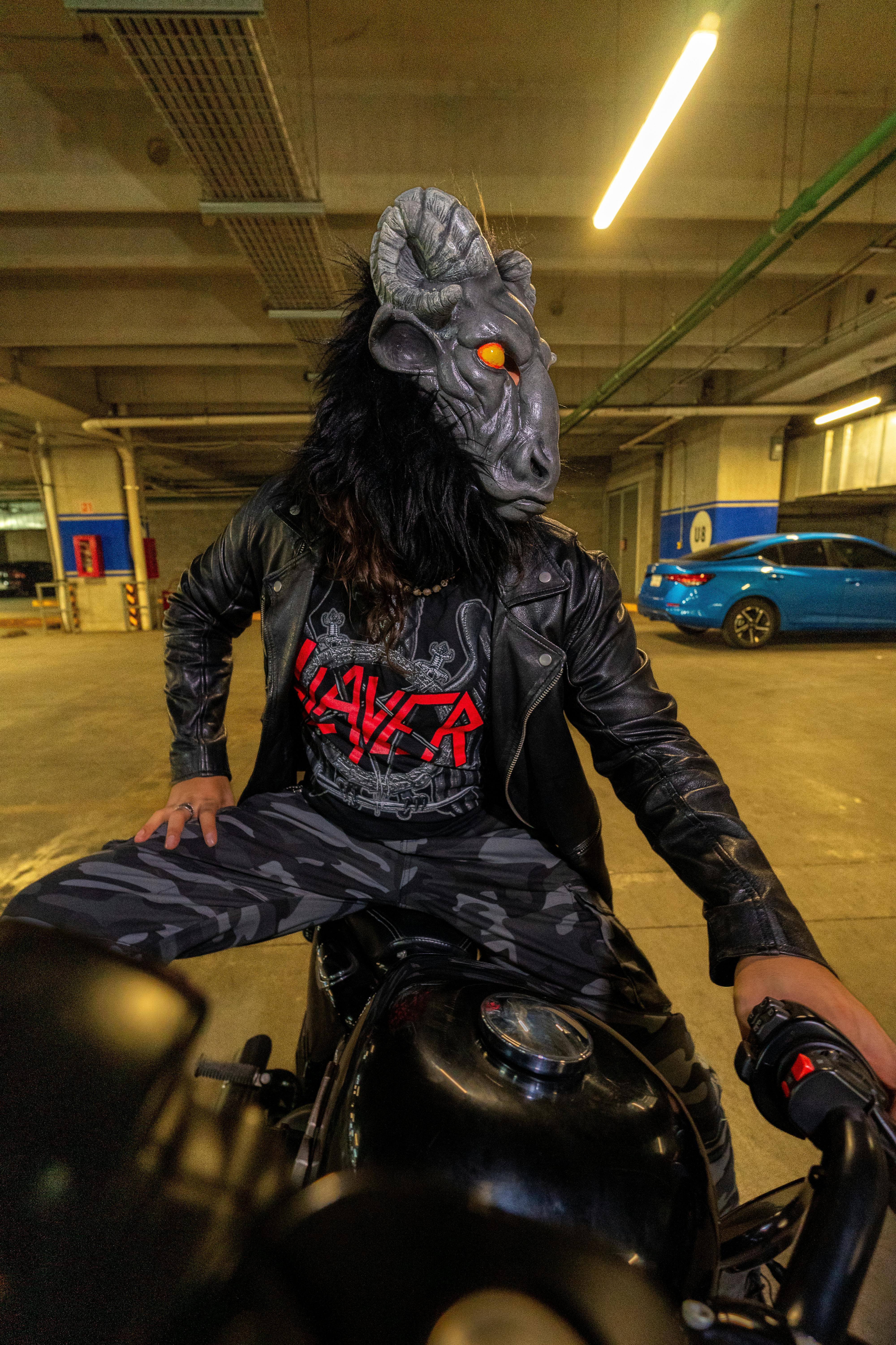Metalhead Wearing a Goat Mask Posing by a Parked Motorcycle · Free ...
