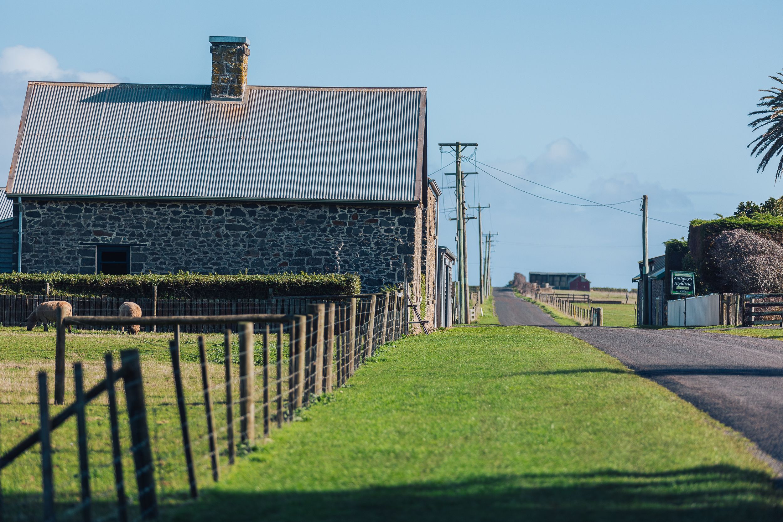 A farm with a fence and a road · Free Stock Photo