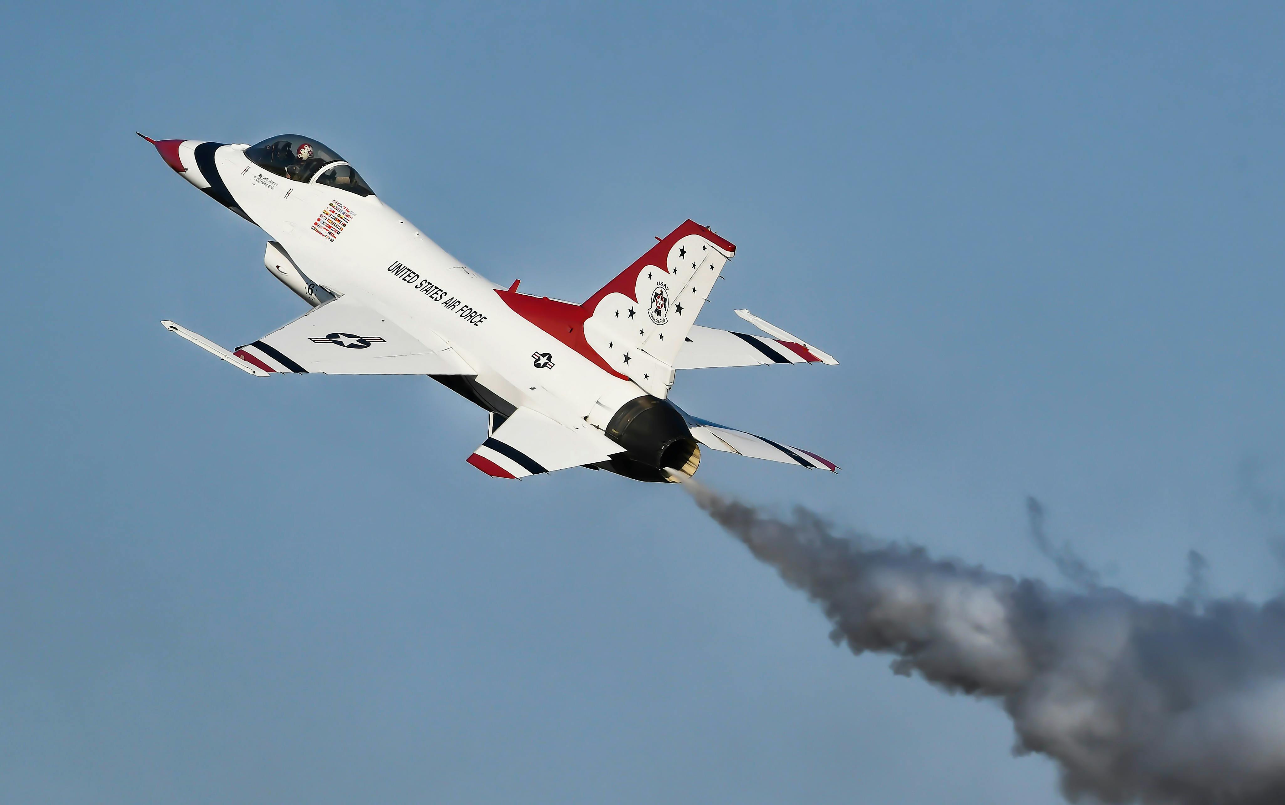 A red white and blue fighter jet flying through the air · Free Stock Photo