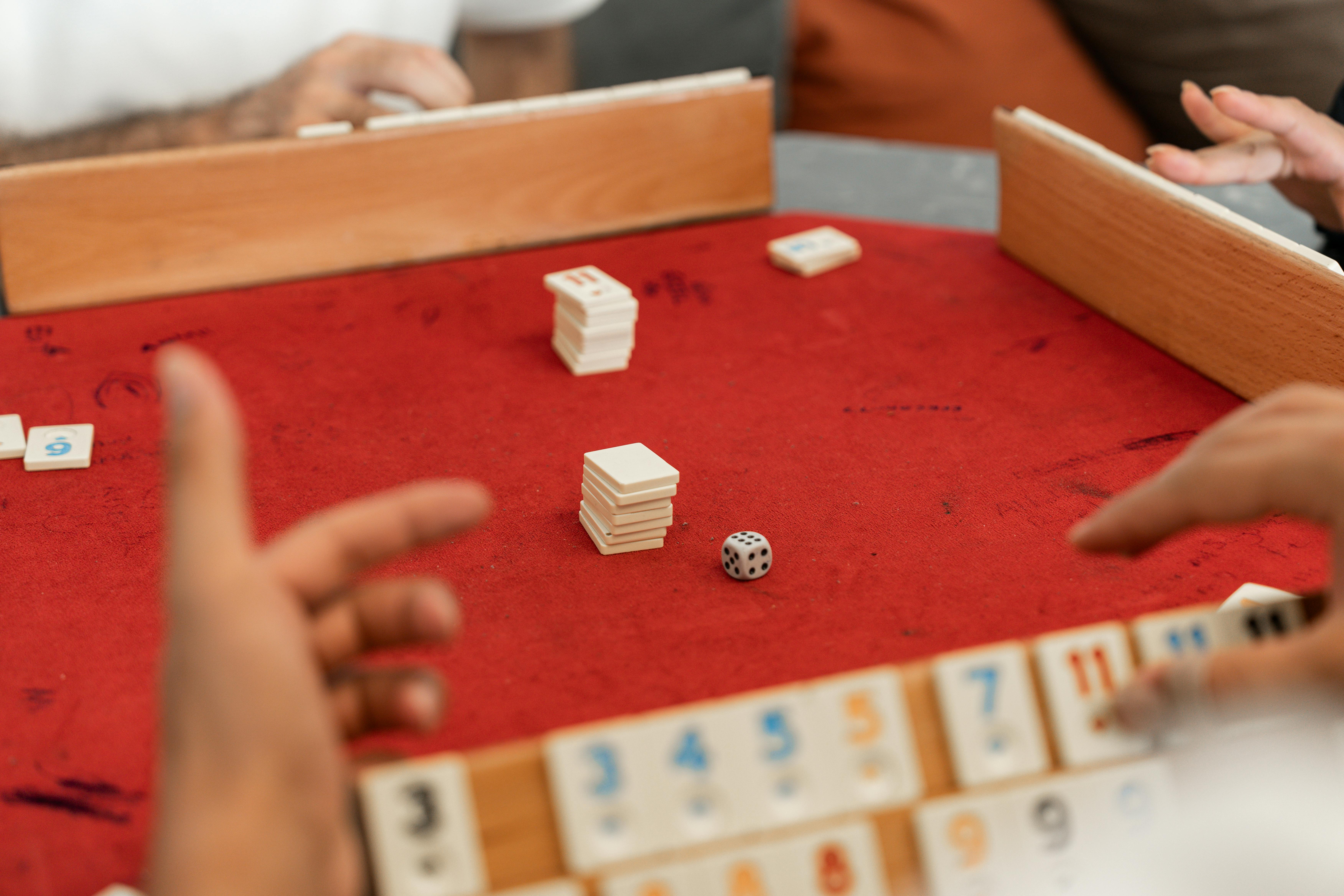 A group of people playing a game of dice · Free Stock Photo