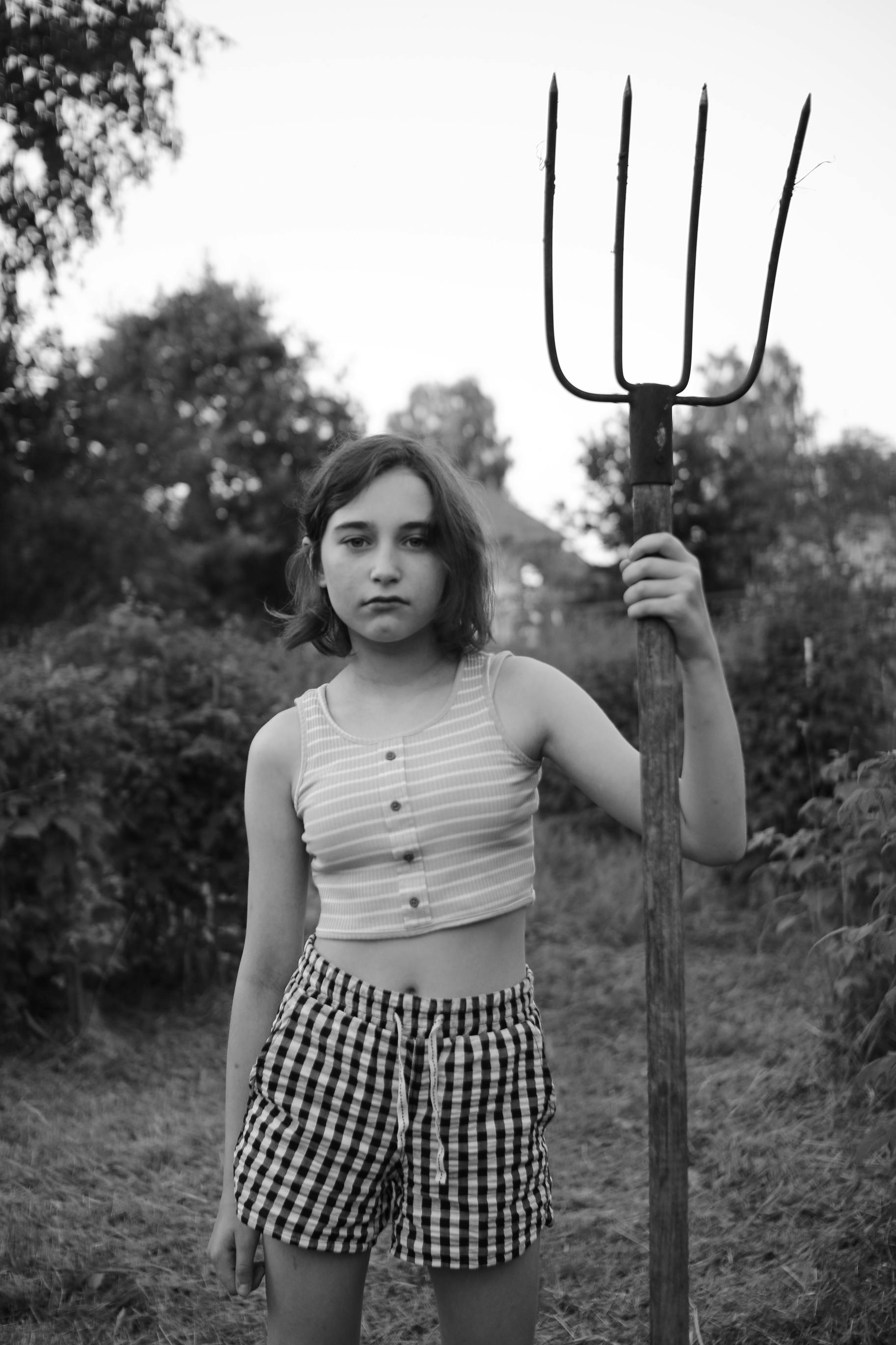 Girl Holding a Pitchfork · Free Stock Photo