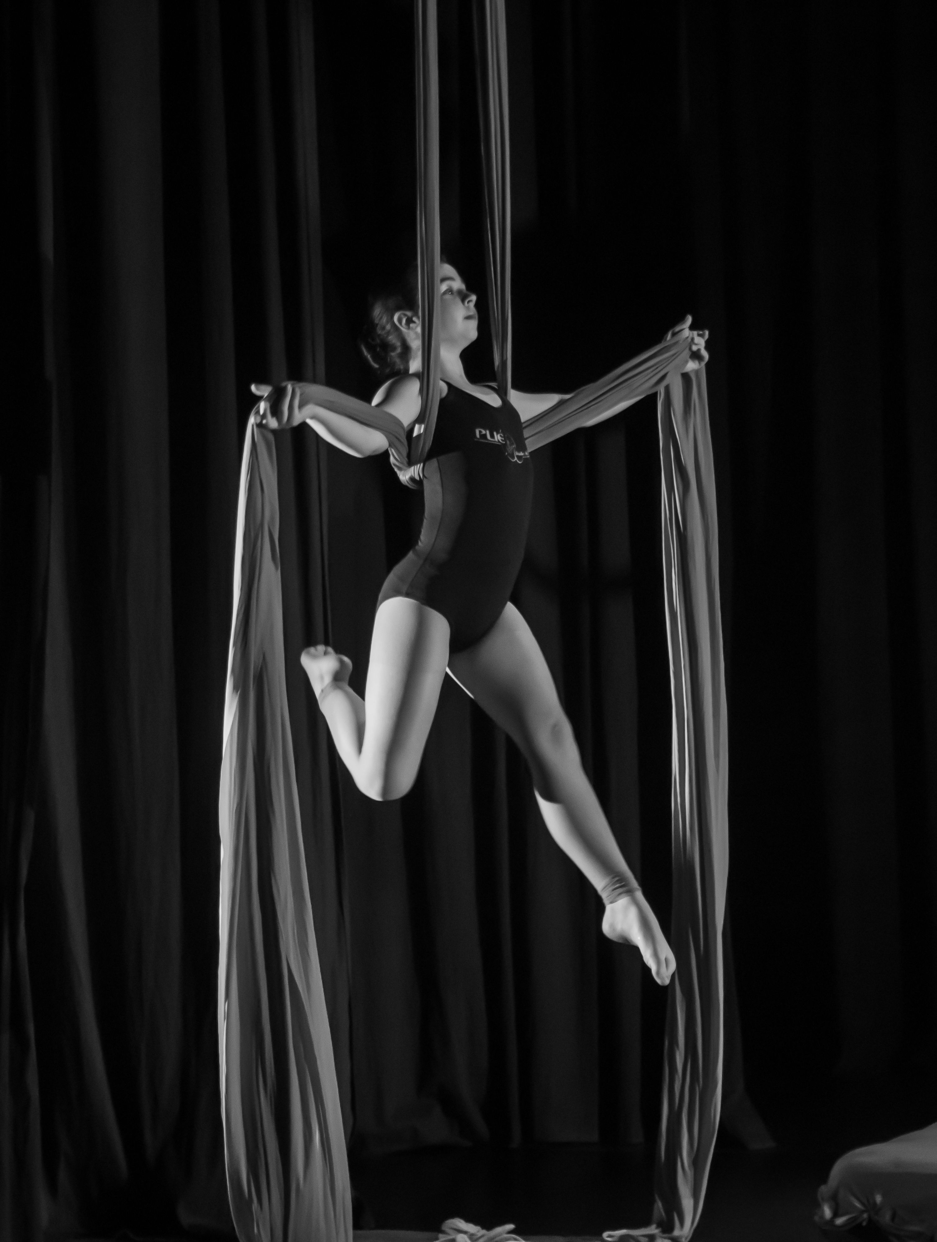 A black and white photo of a woman doing aerial · Free Stock Photo