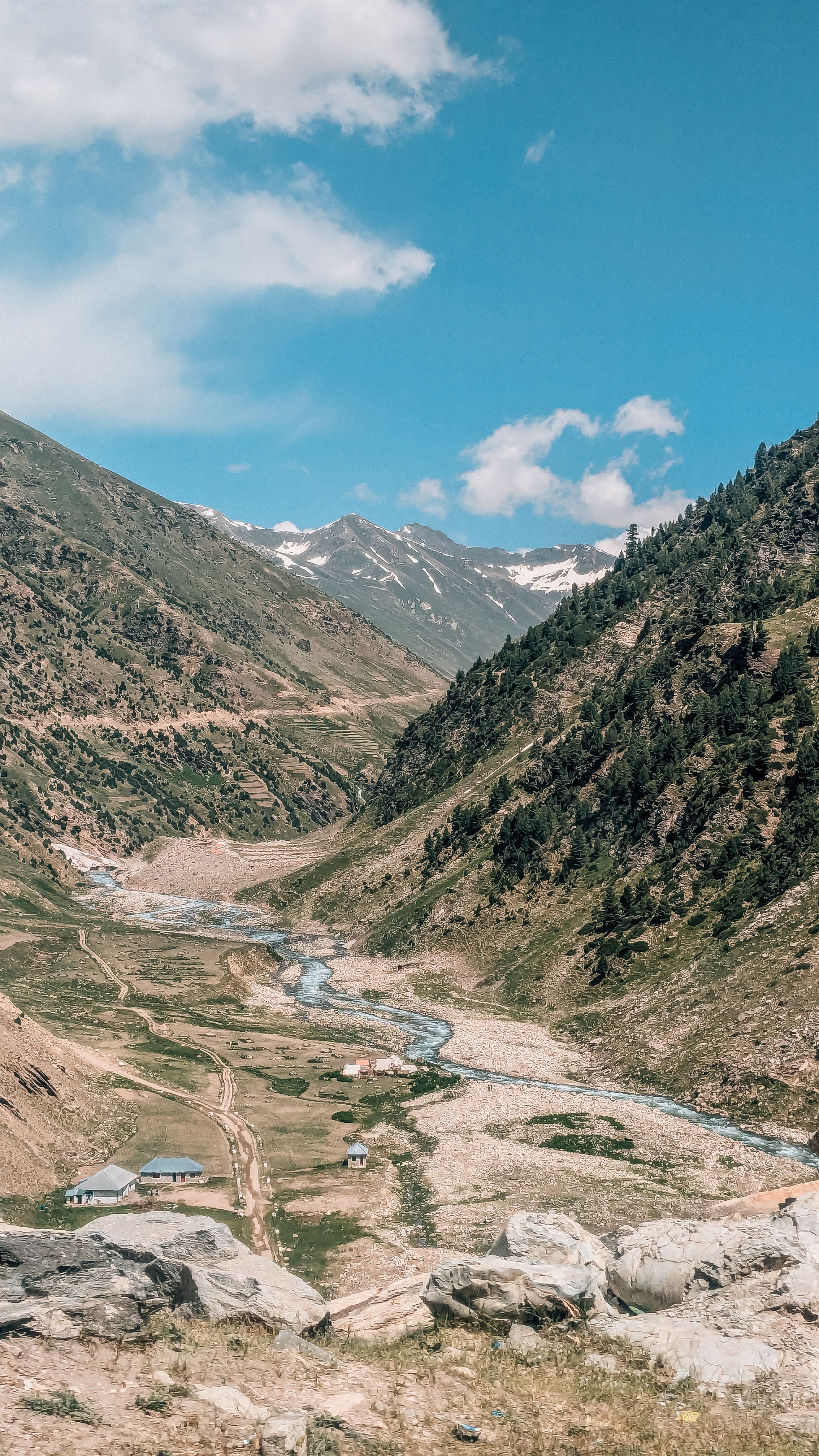 A river flowing through a valley in the mountains · Free Stock Photo