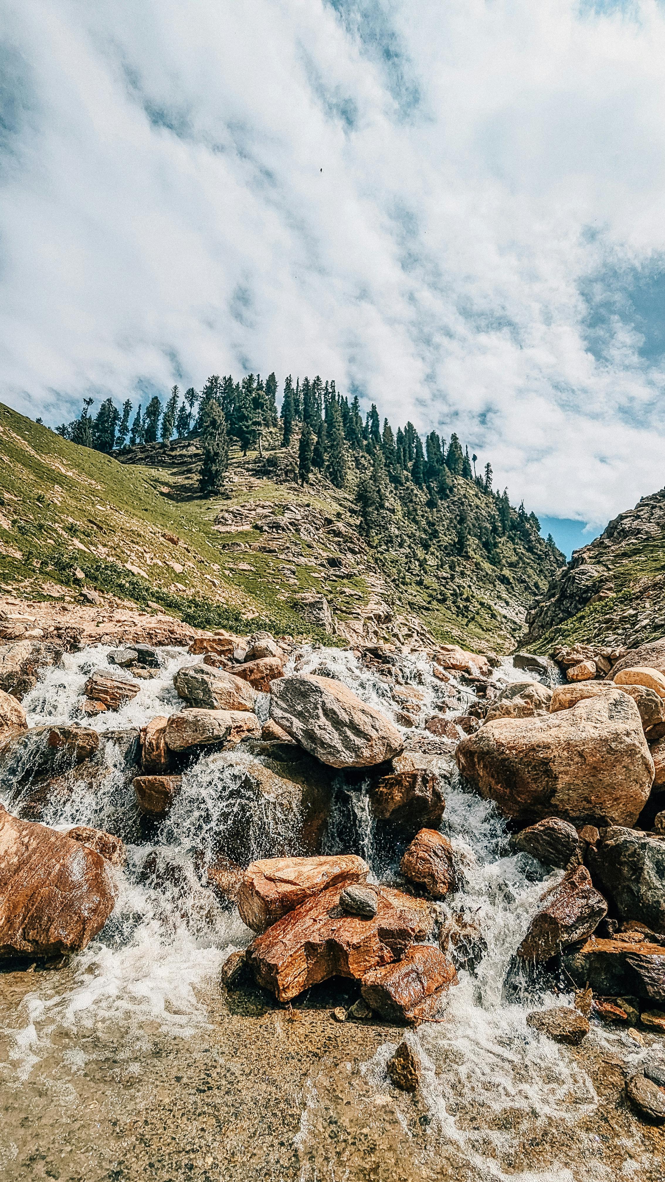 A stream flowing through a rocky landscape · Free Stock Photo