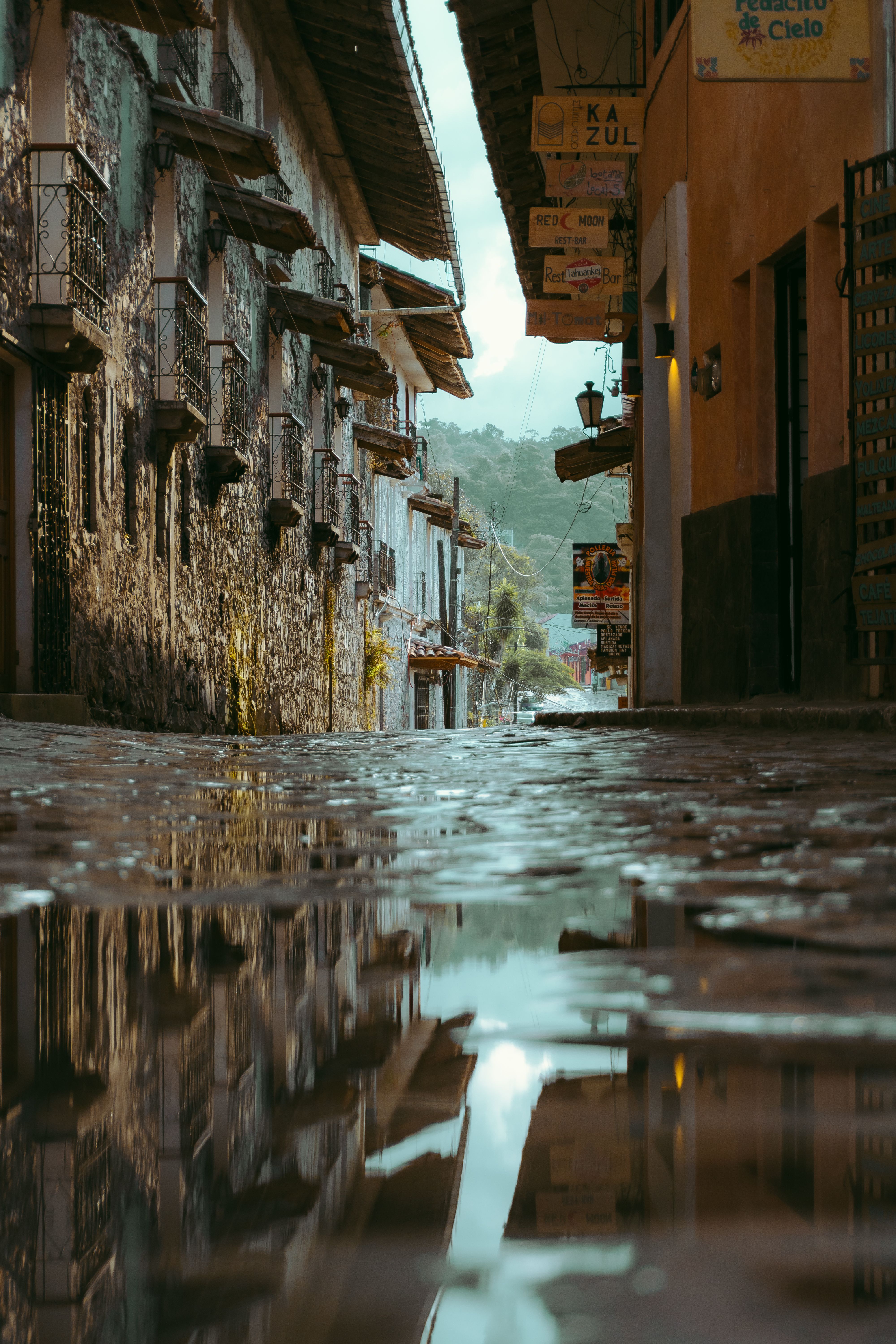 A puddle of water on the street in a small town · Free Stock Photo