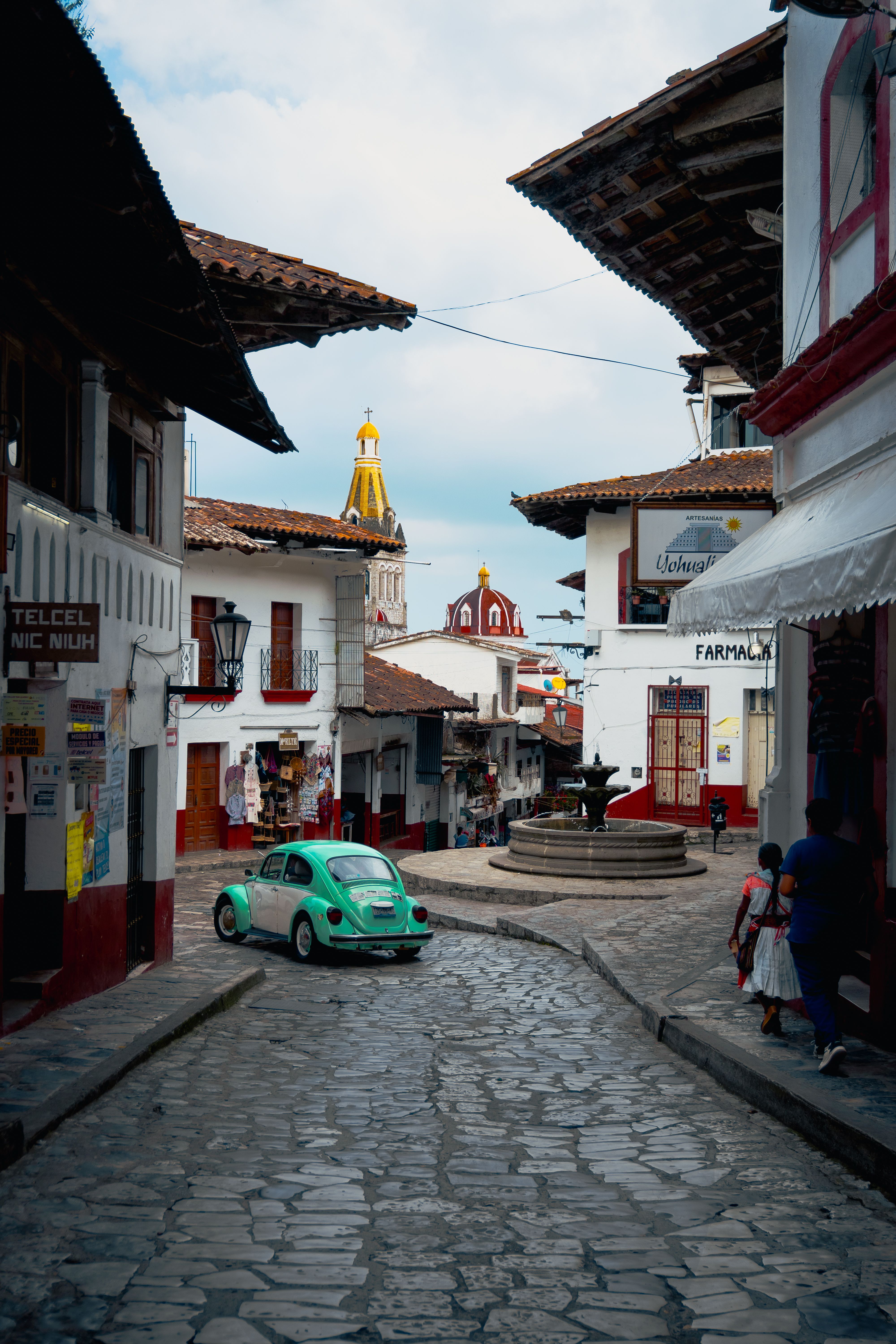 A car is driving down a cobblestone street · Free Stock Photo