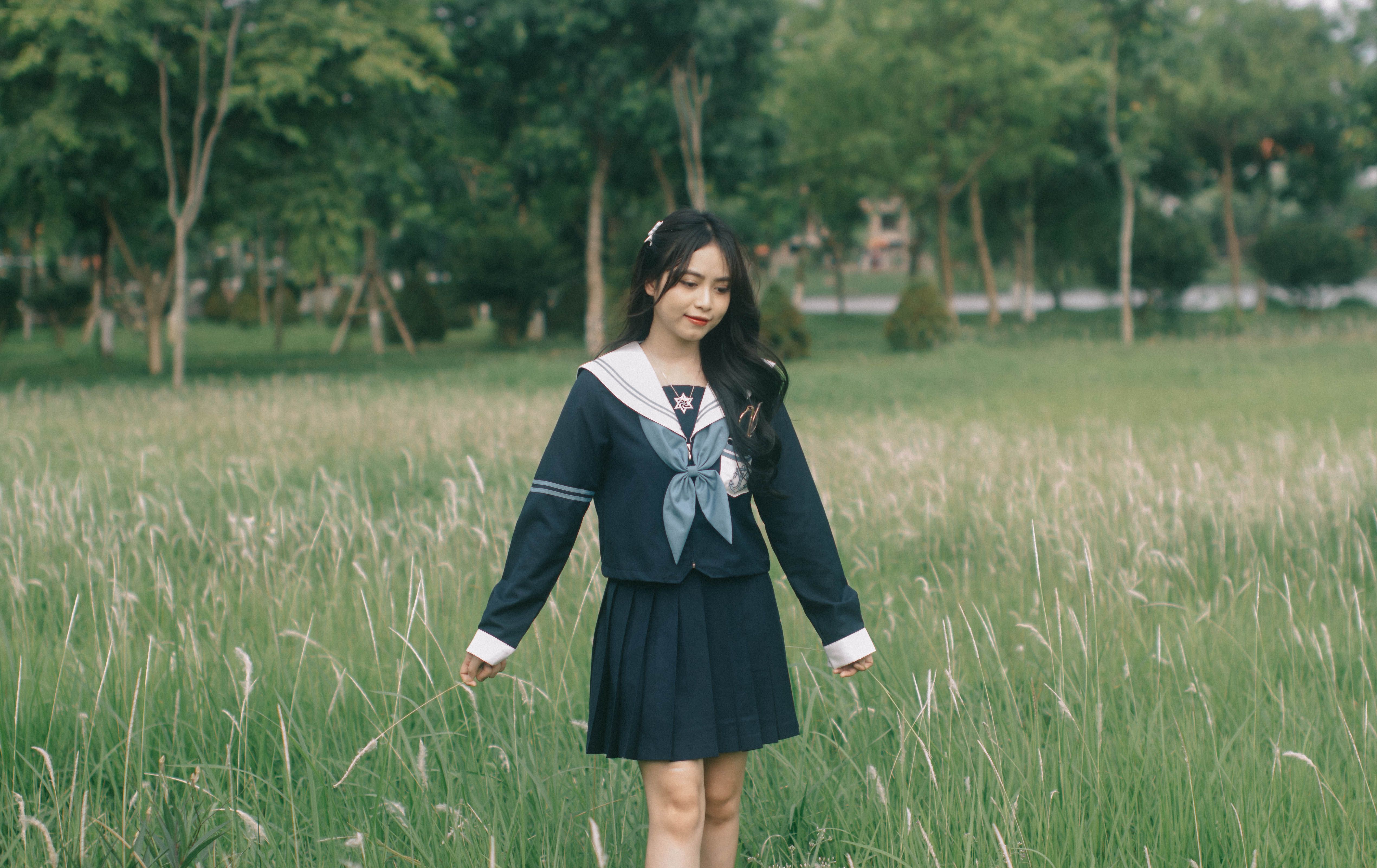Young Model in Sailor-Style School Uniform Standing on a Meadow in a ...