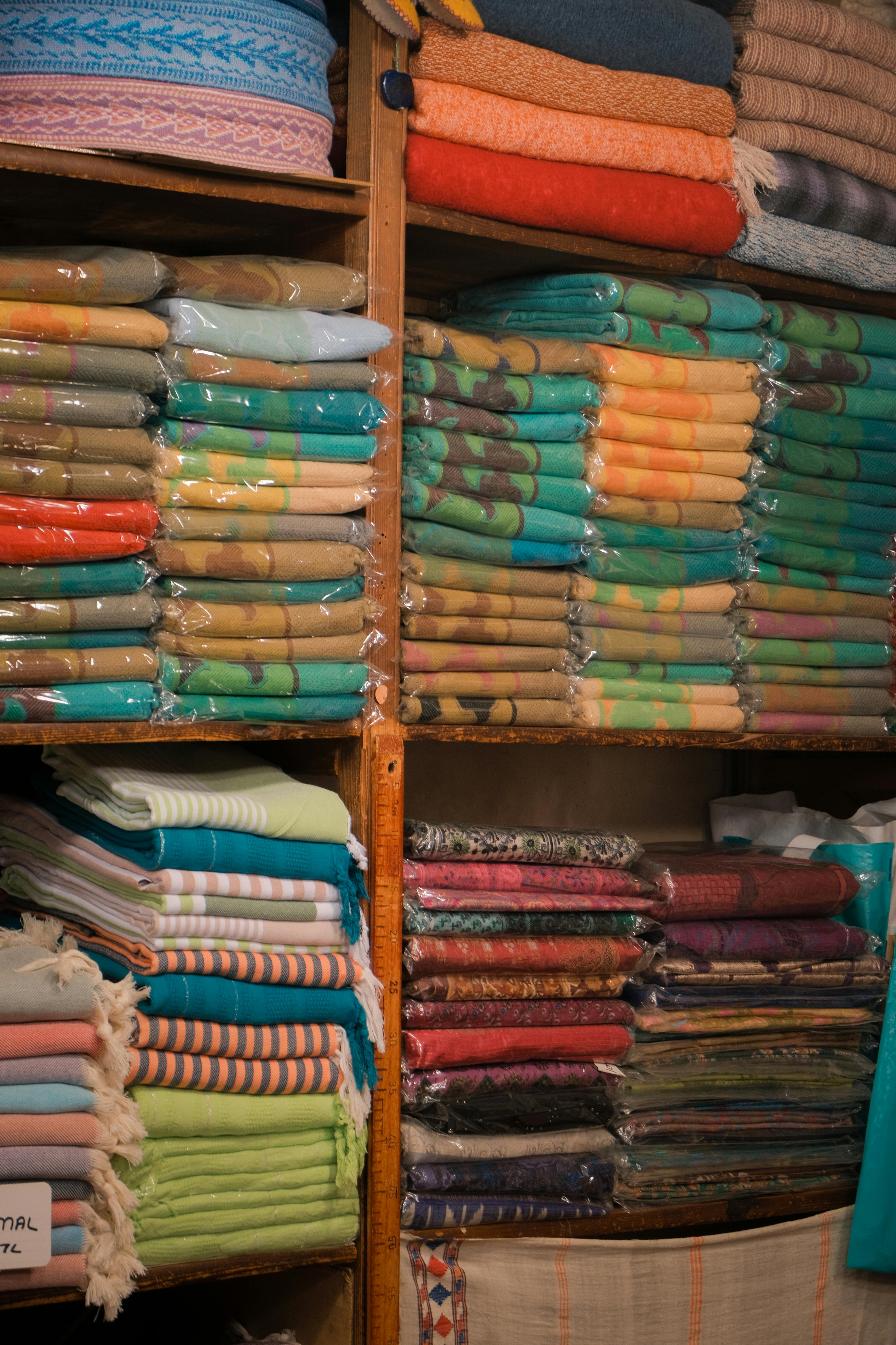 Abundance of Colorful Towels and Fabrics on Shelves · Free Stock Photo