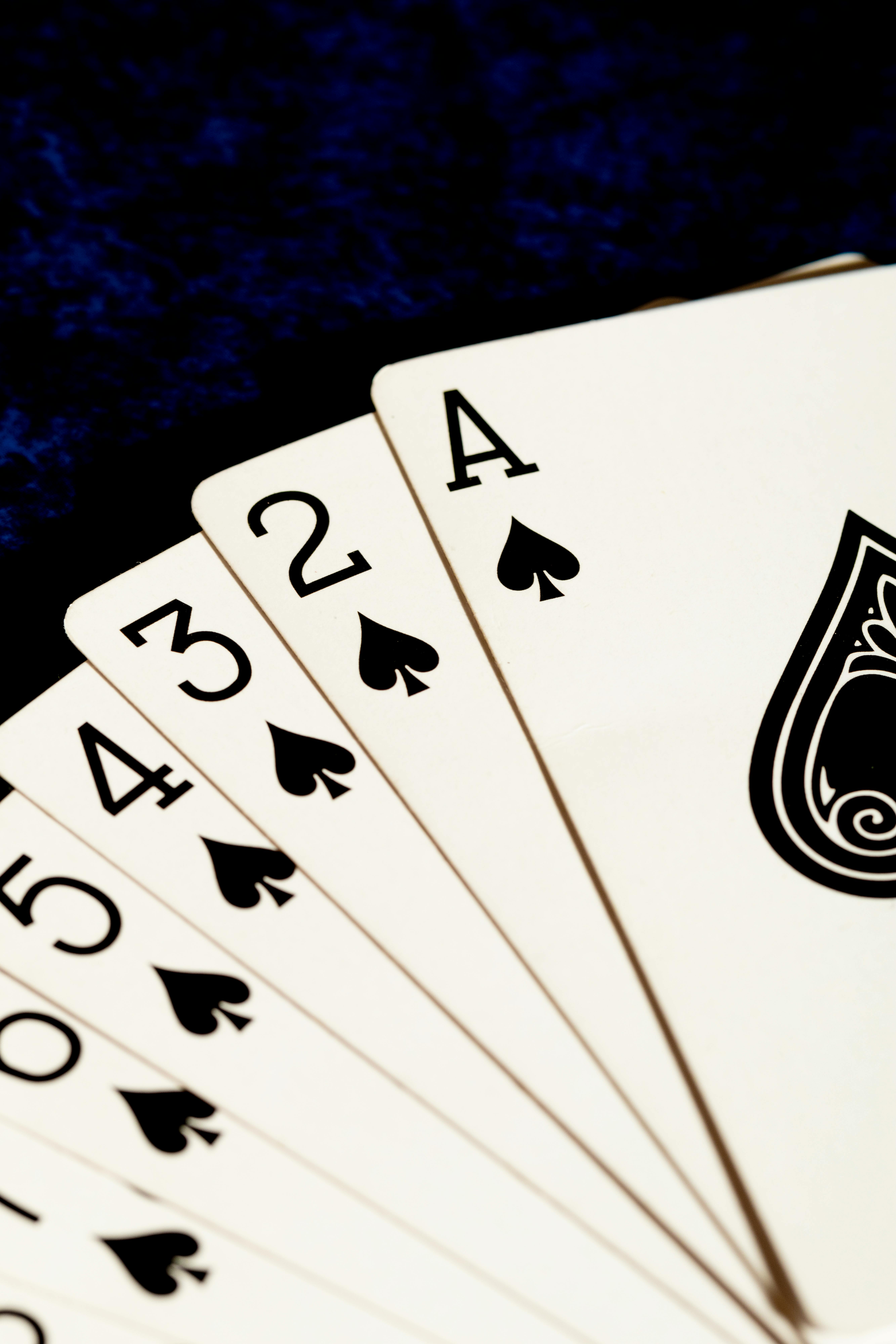 A close up of four playing cards with the number four · Free Stock Photo