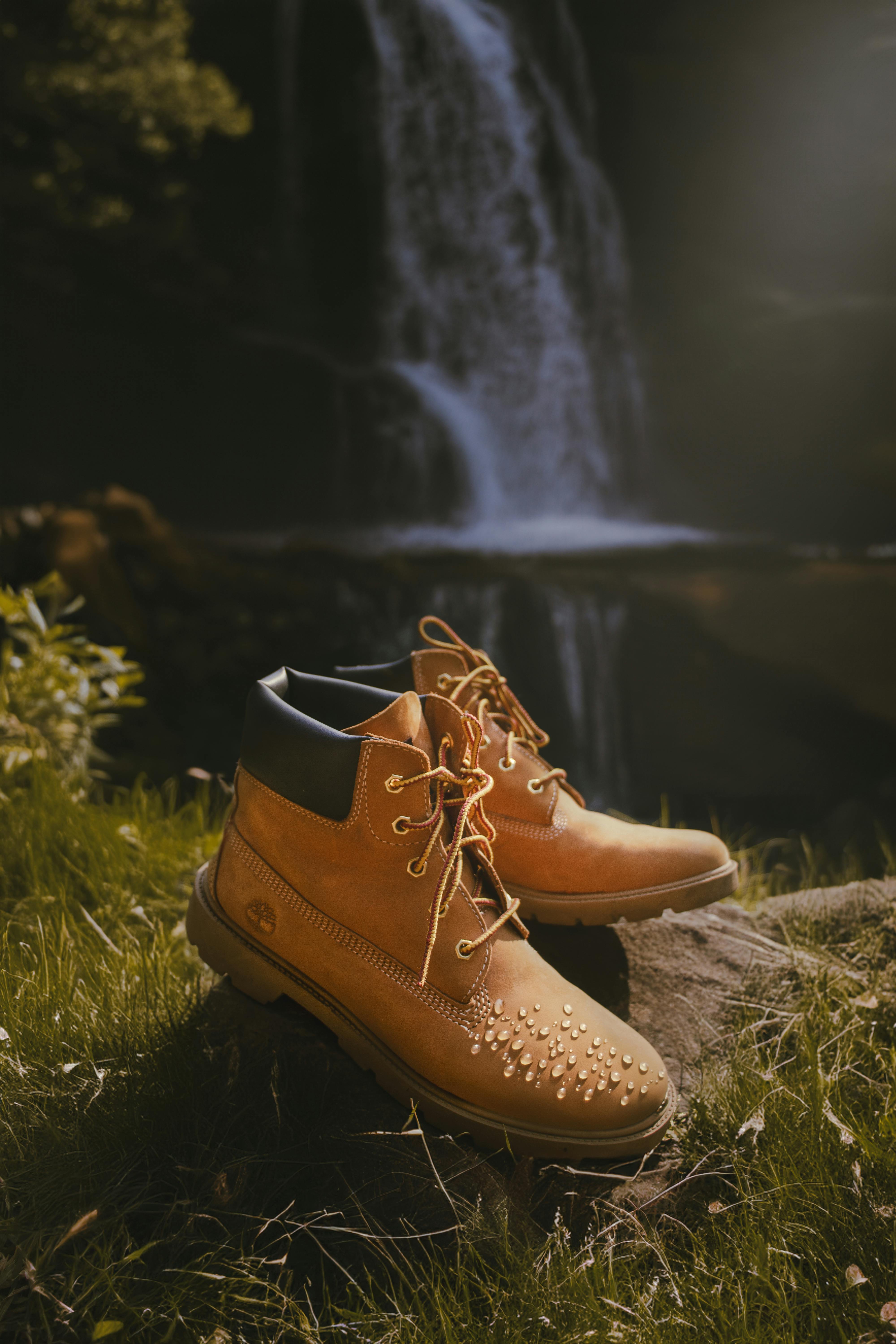 Boots on Grass near Waterfall · Free Stock Photo