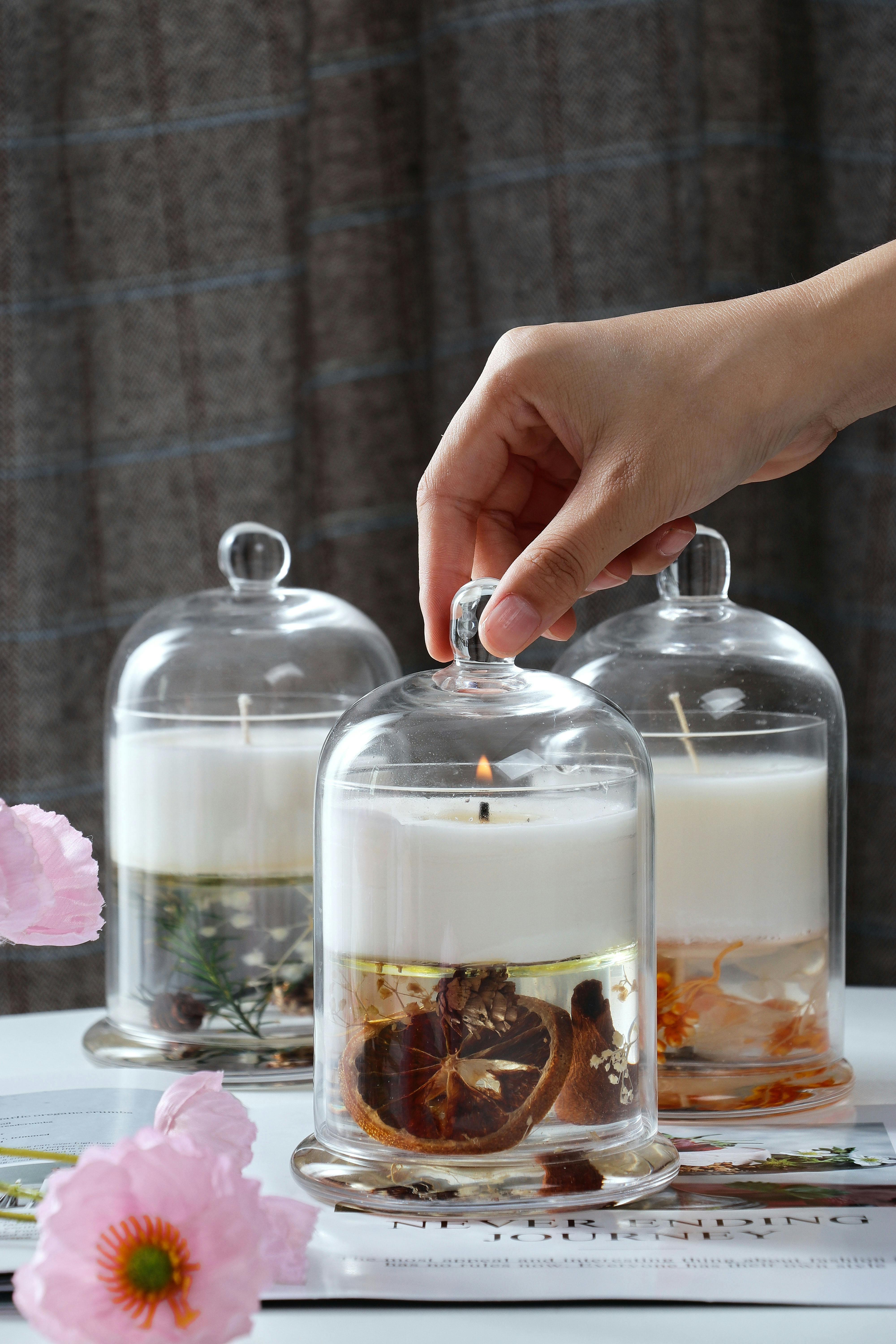 A Hand Touching Candle Decorations · Free Stock Photo