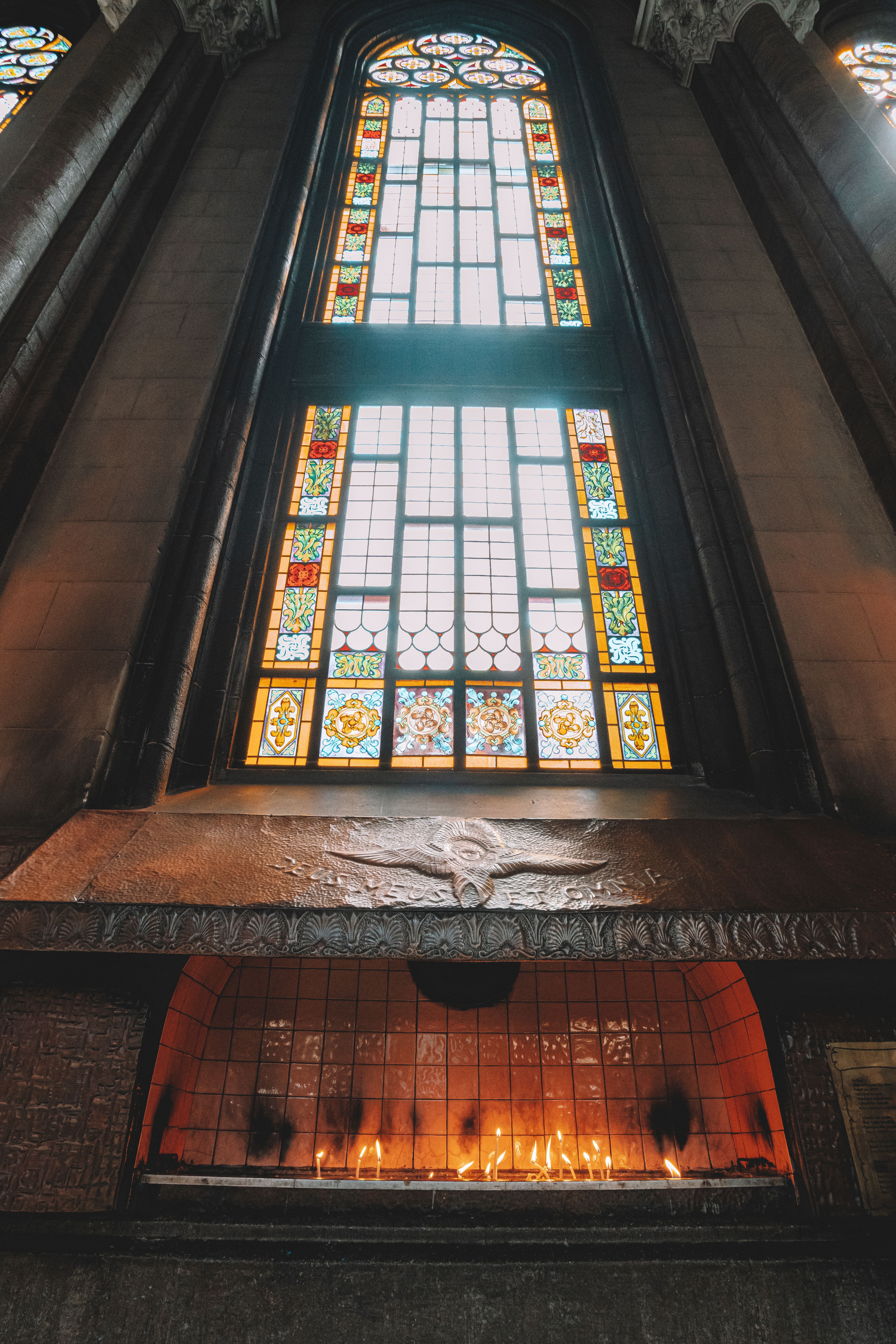 A large stained glass window with a fire in it · Free Stock Photo
