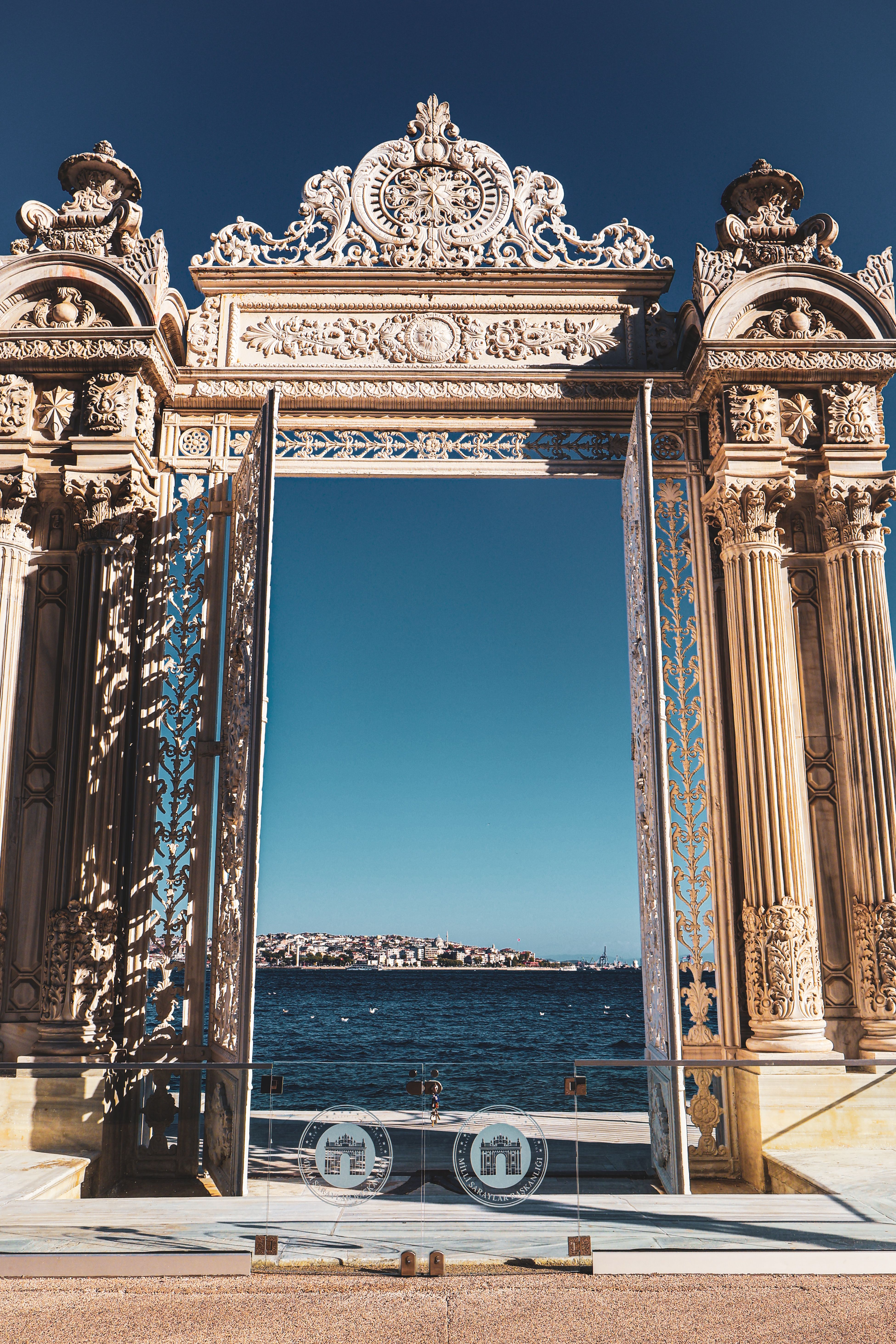 A large ornate gate with a blue sky in the background · Free Stock Photo