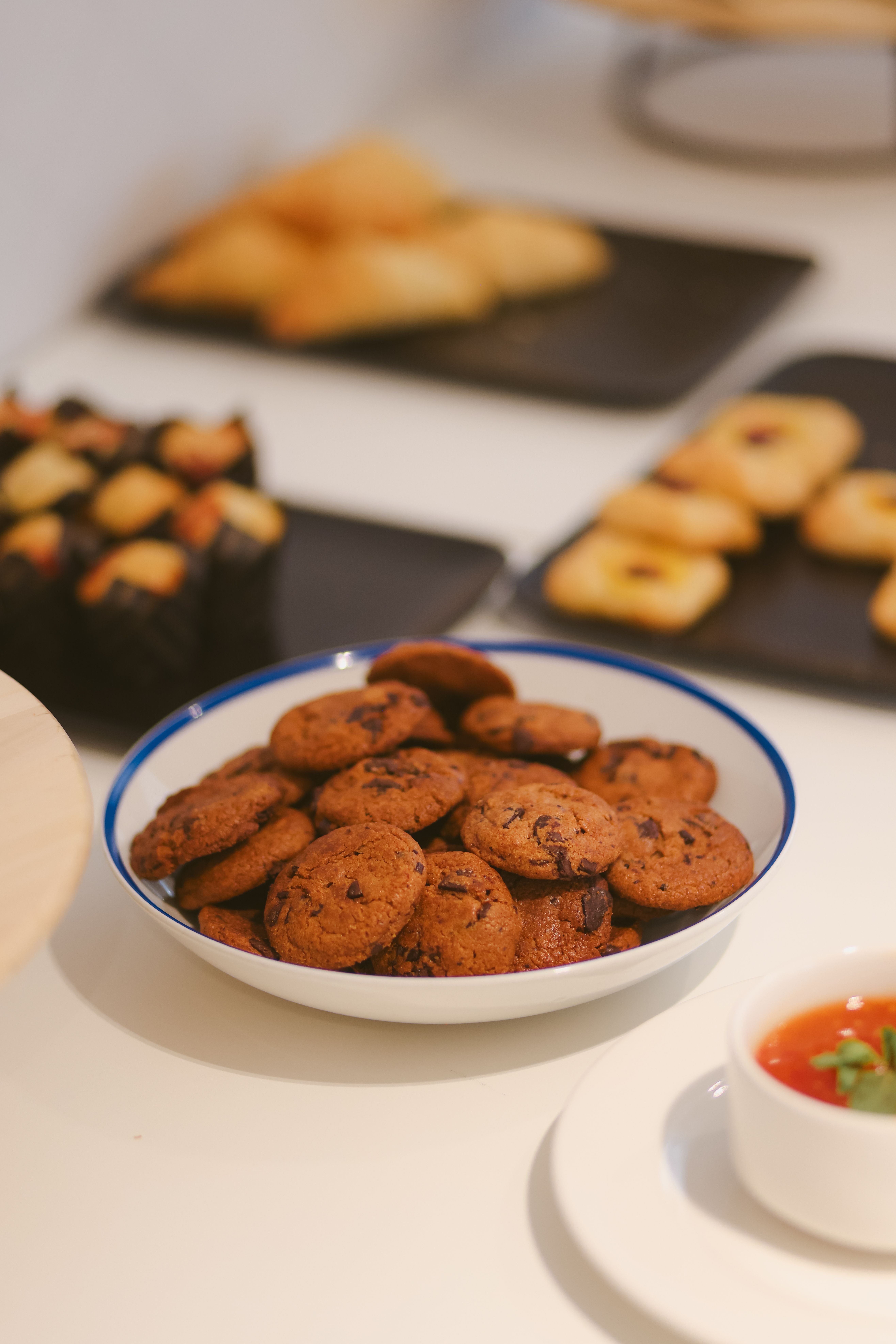 Baked Cookies on Plate Beside Teapot · Free Stock Photo