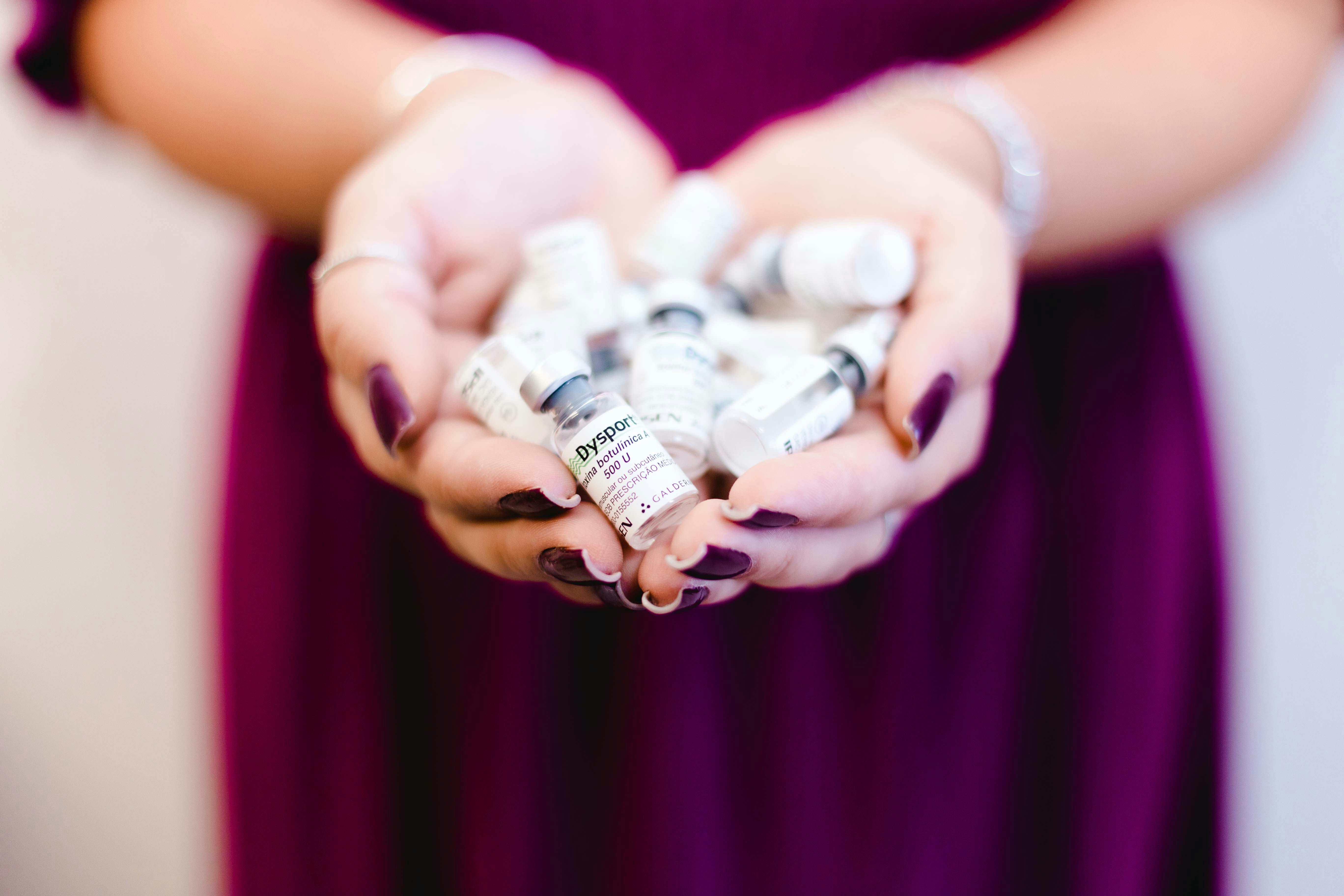 Close-up of Pill Bottles in Womans Hands · Free Stock Photo