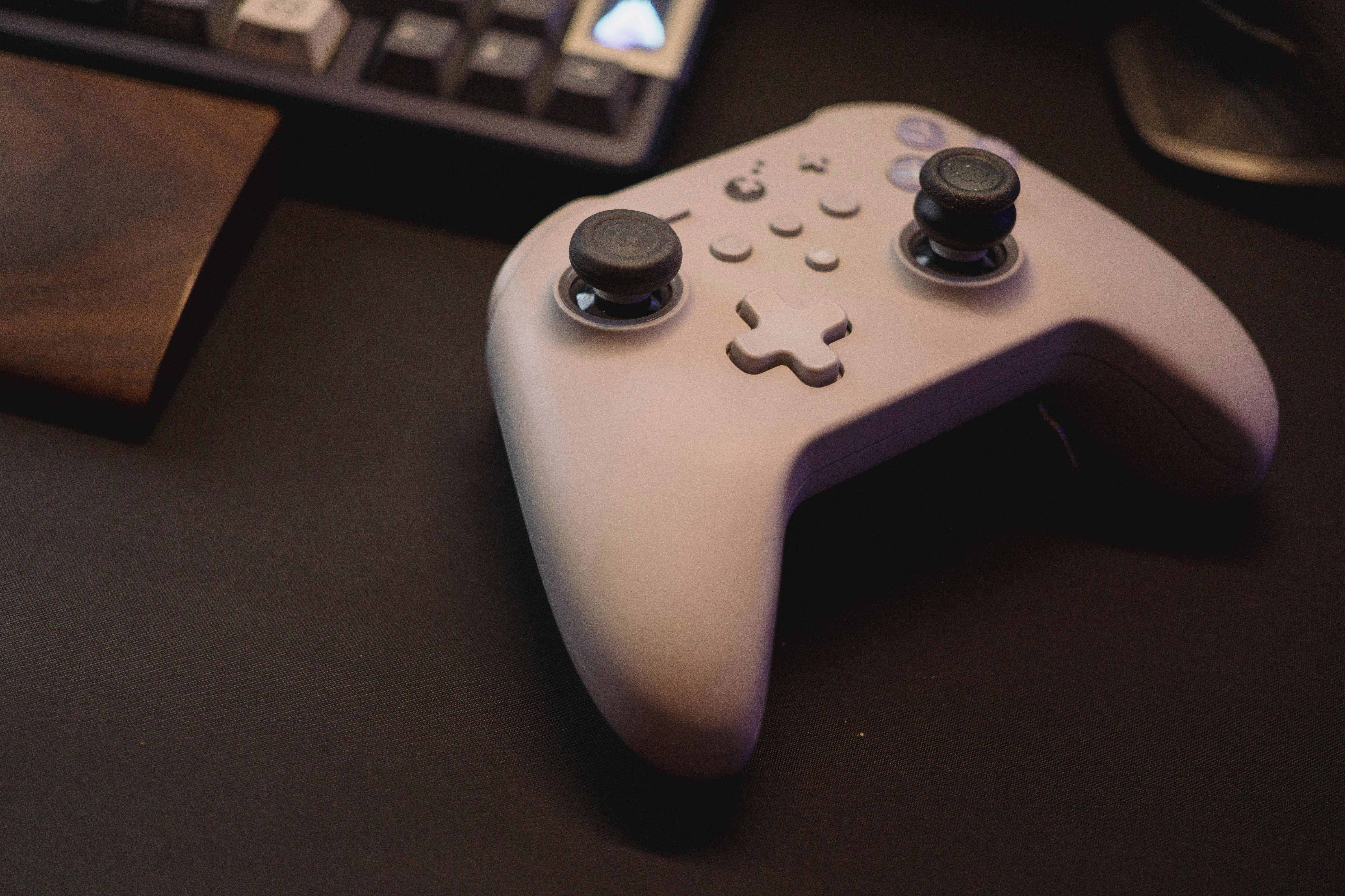 Messy Table with Game Controllers and a Beer Bottle · Free Stock Photo