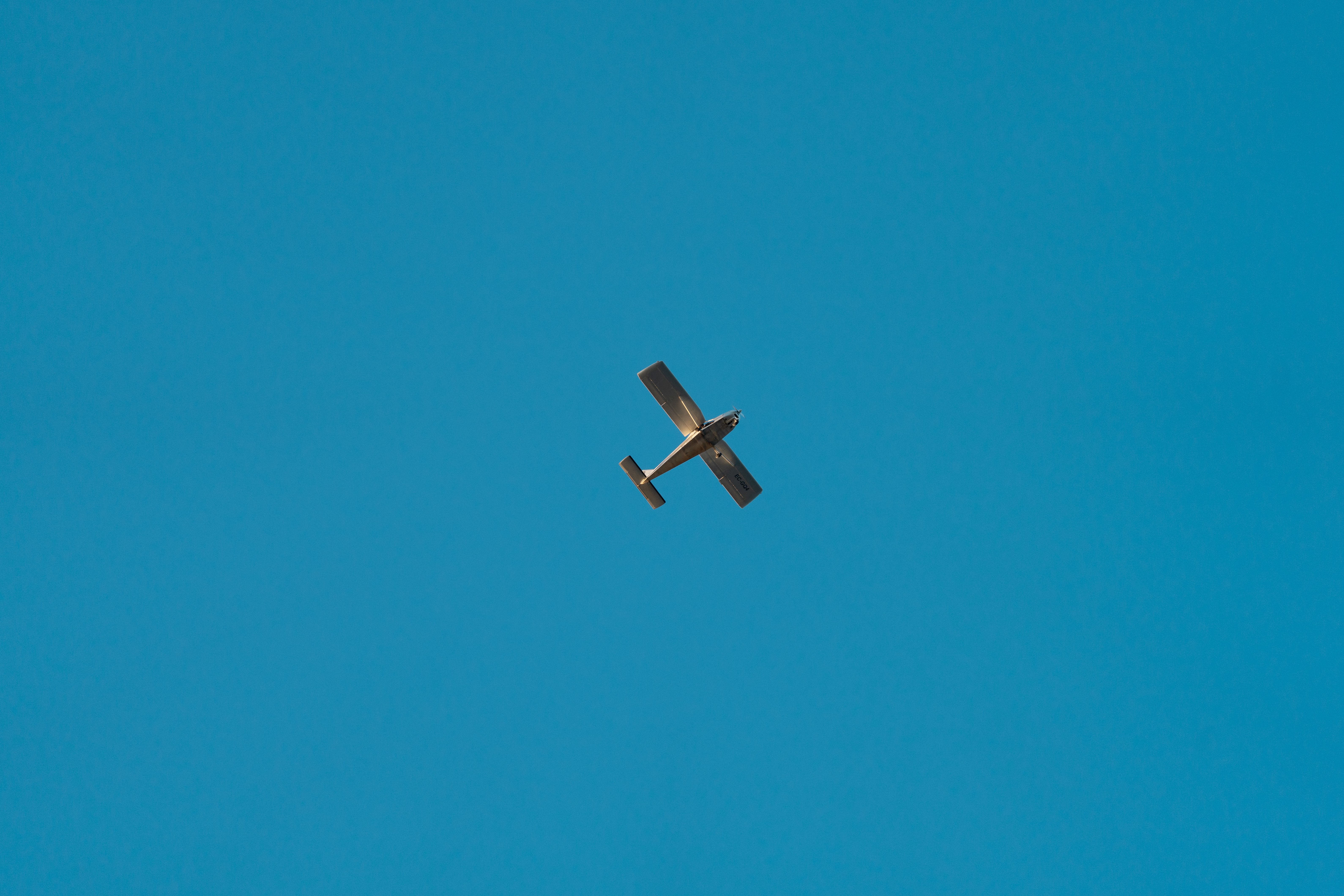 Small plane crossing the blue sky · Free Stock Photo